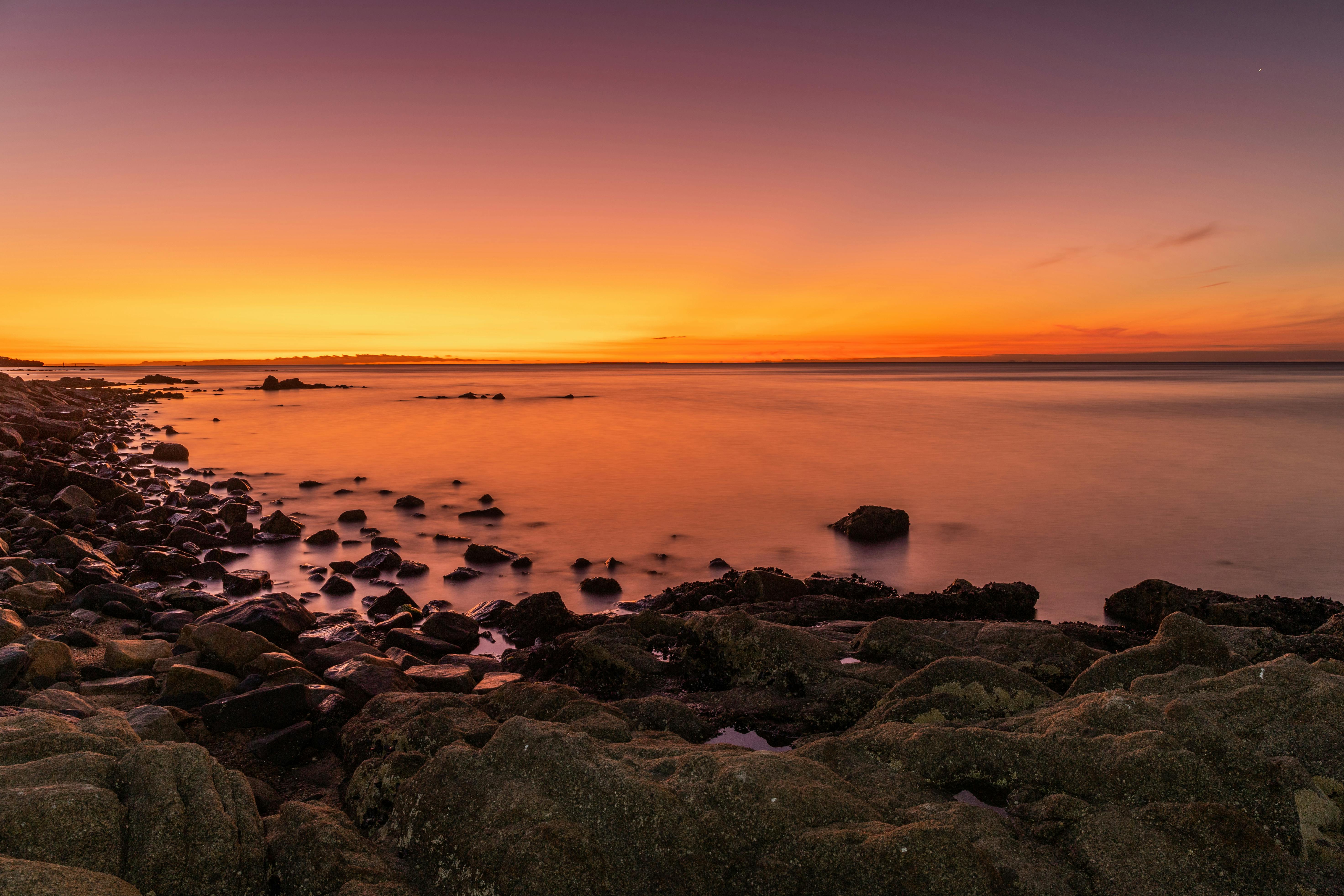 Rocks on Seashore during Sunset · Free Stock Photo