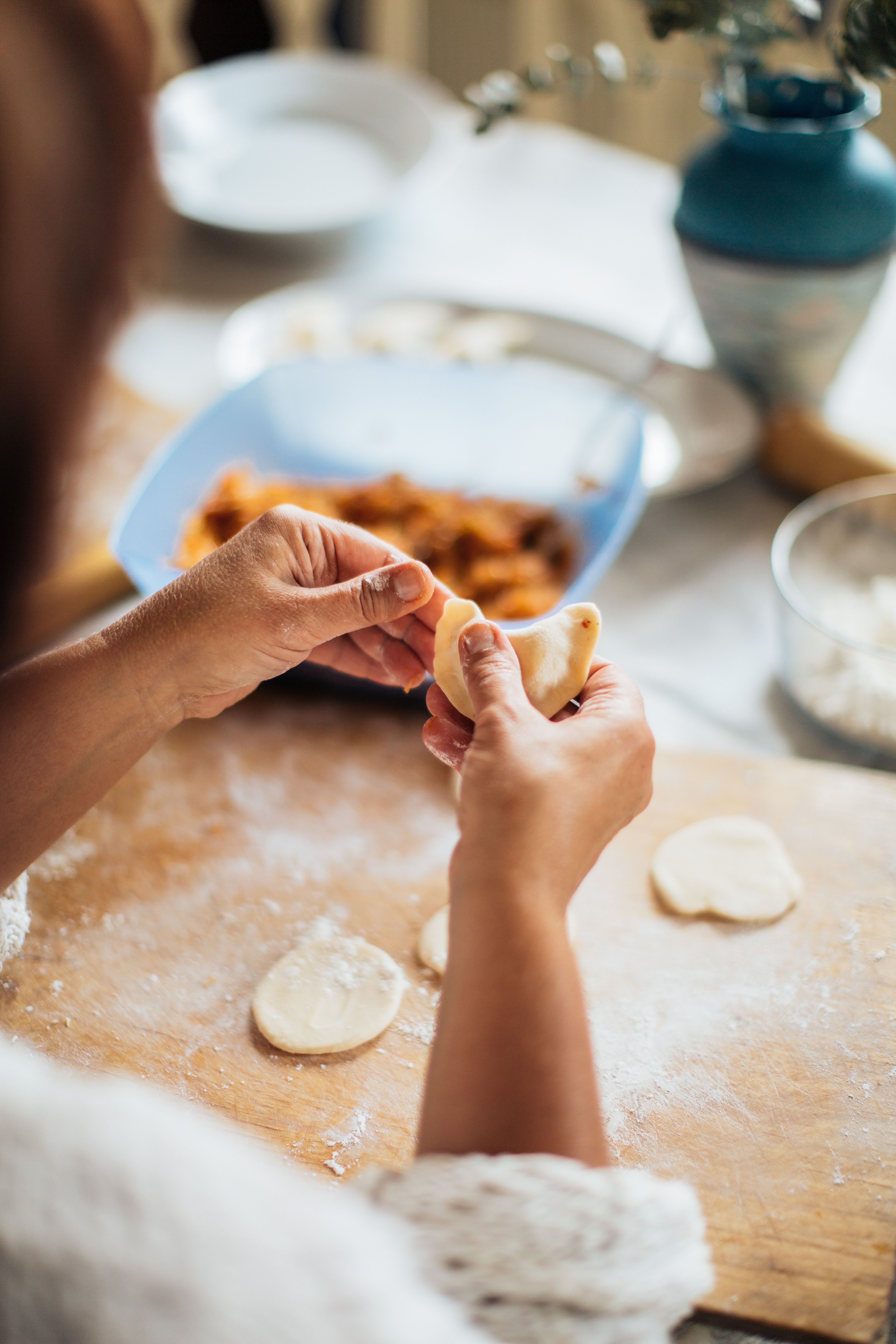 Person Putting Pelmeni in White Ceramic Plate · Free Stock Photo