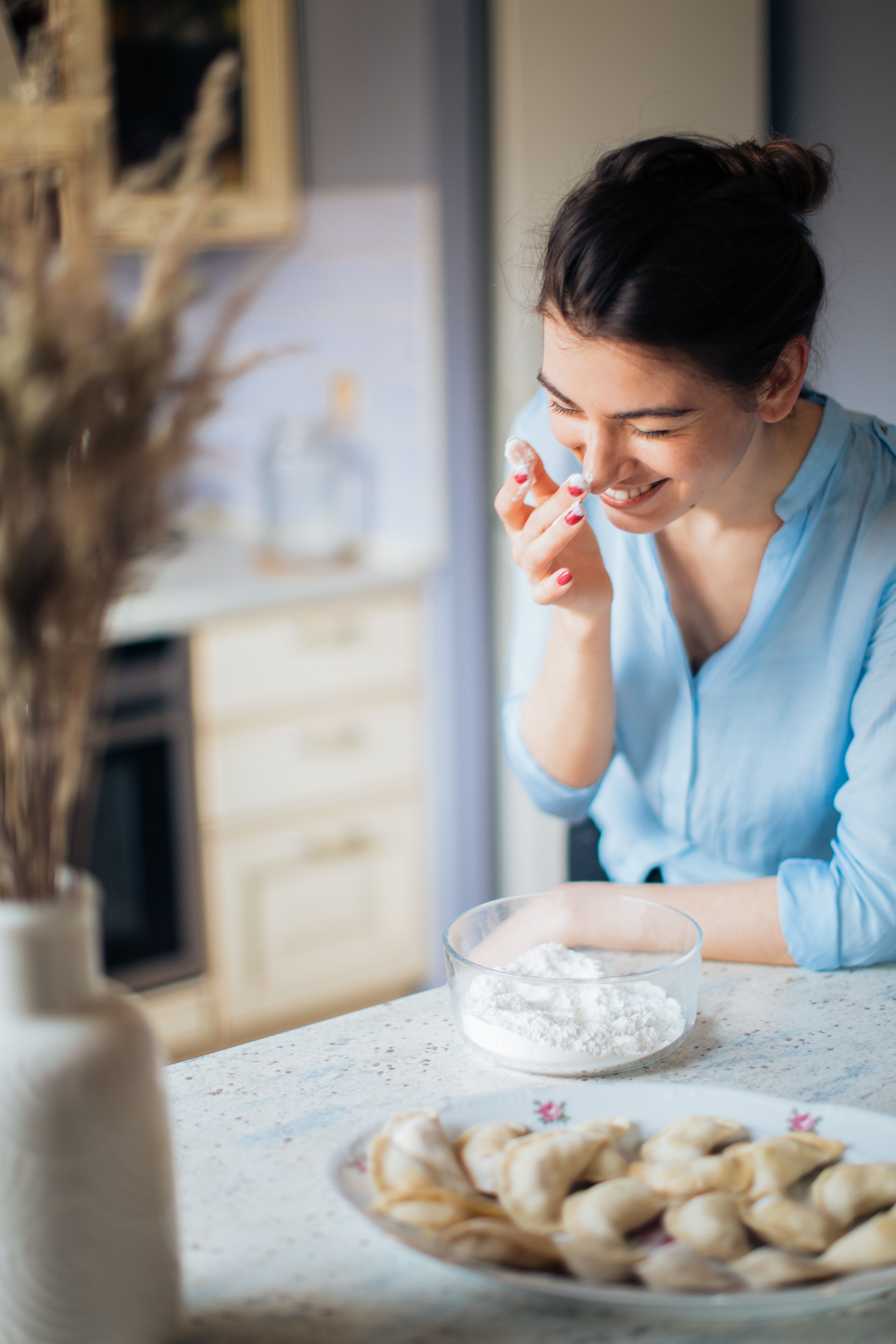 Woman in Blue Long Sleeve Shirt Touching Flour in Bowl · Free Stock Photo