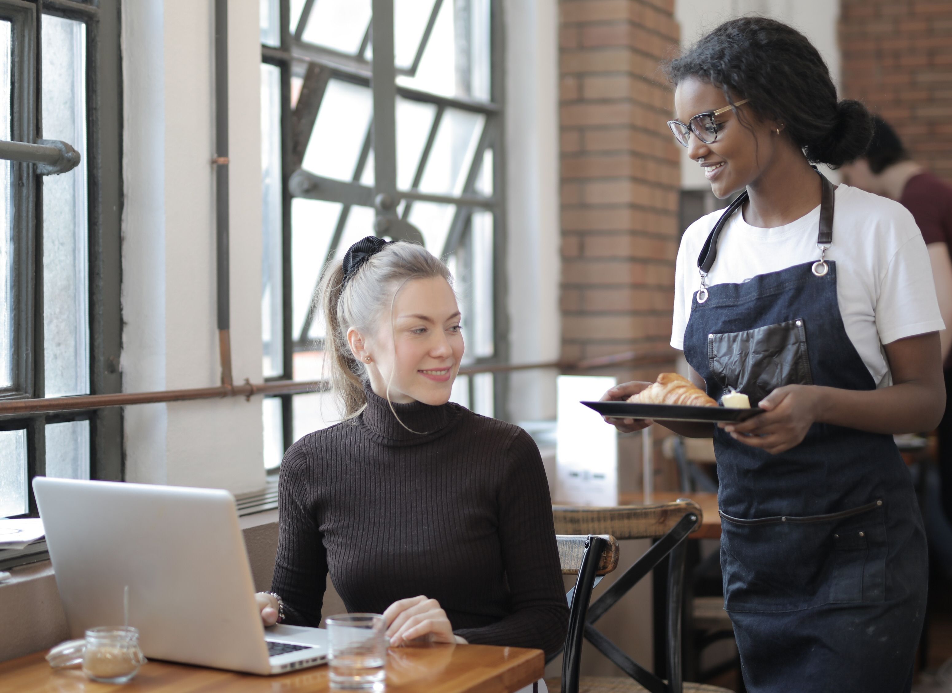 Woman Wearing An Apron Serving Food · Free Stock Photo