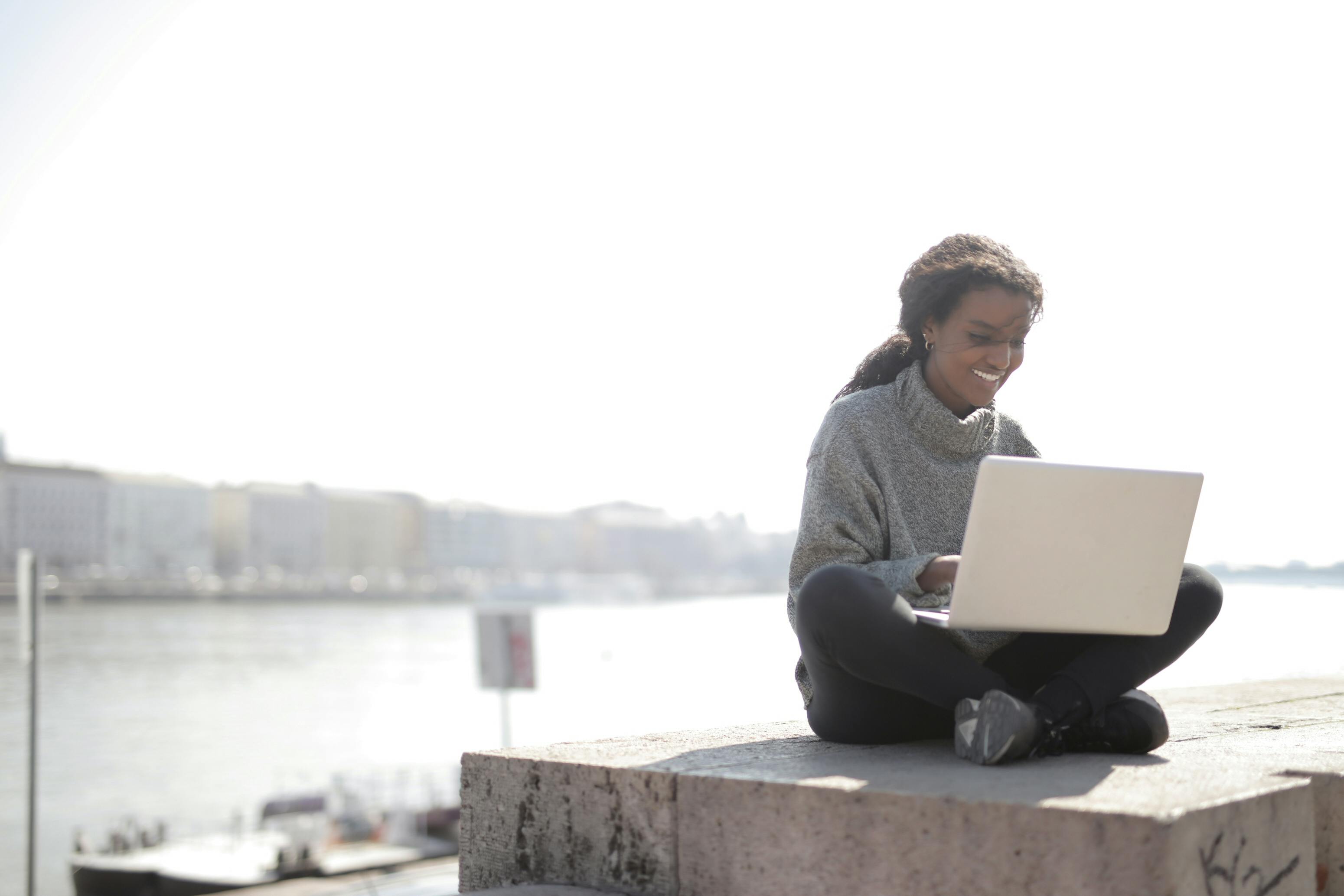 Woman Using Laptop Outdoors · Free Stock Photo