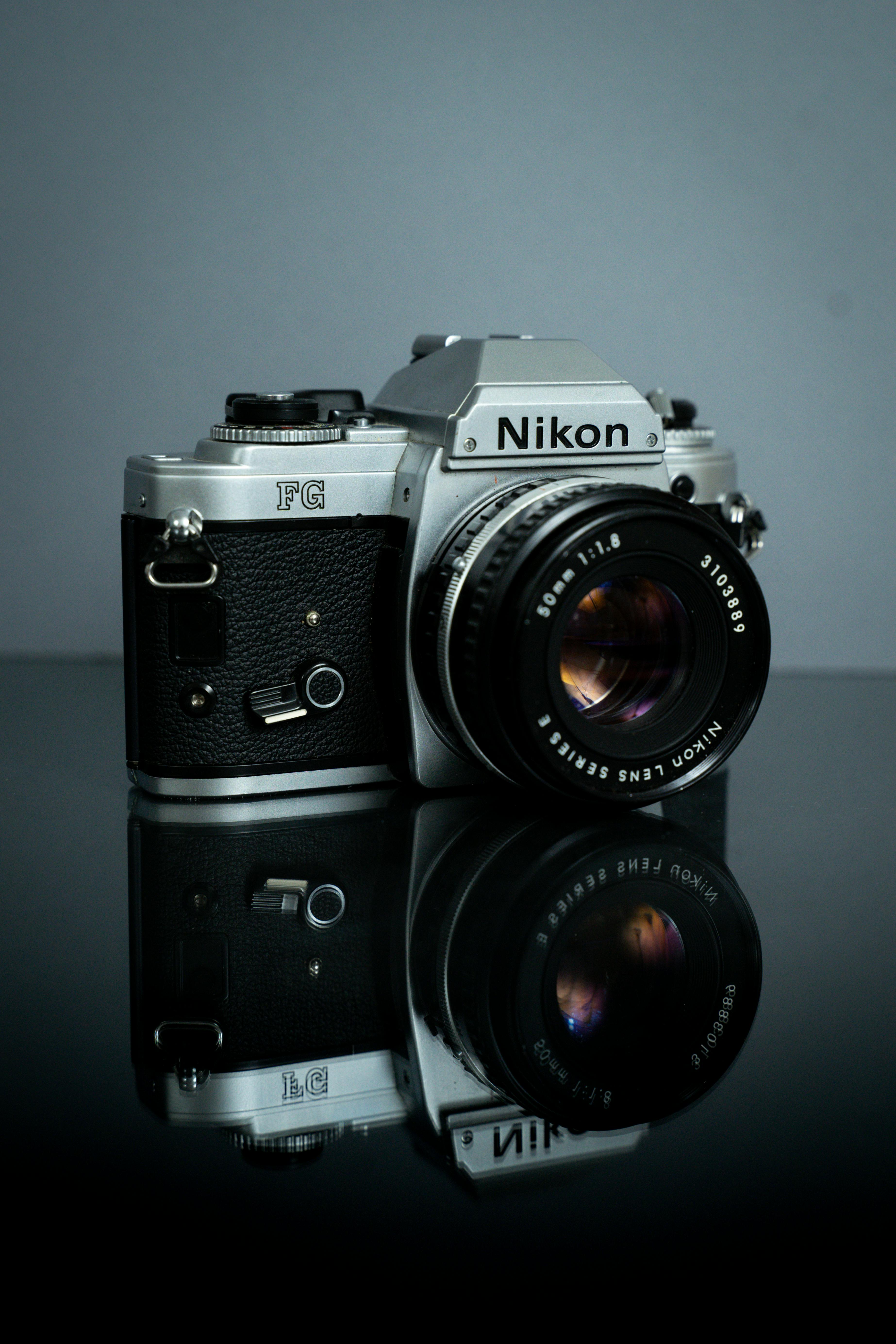 Black Dslr Camera on White Surface · Free Stock Photo