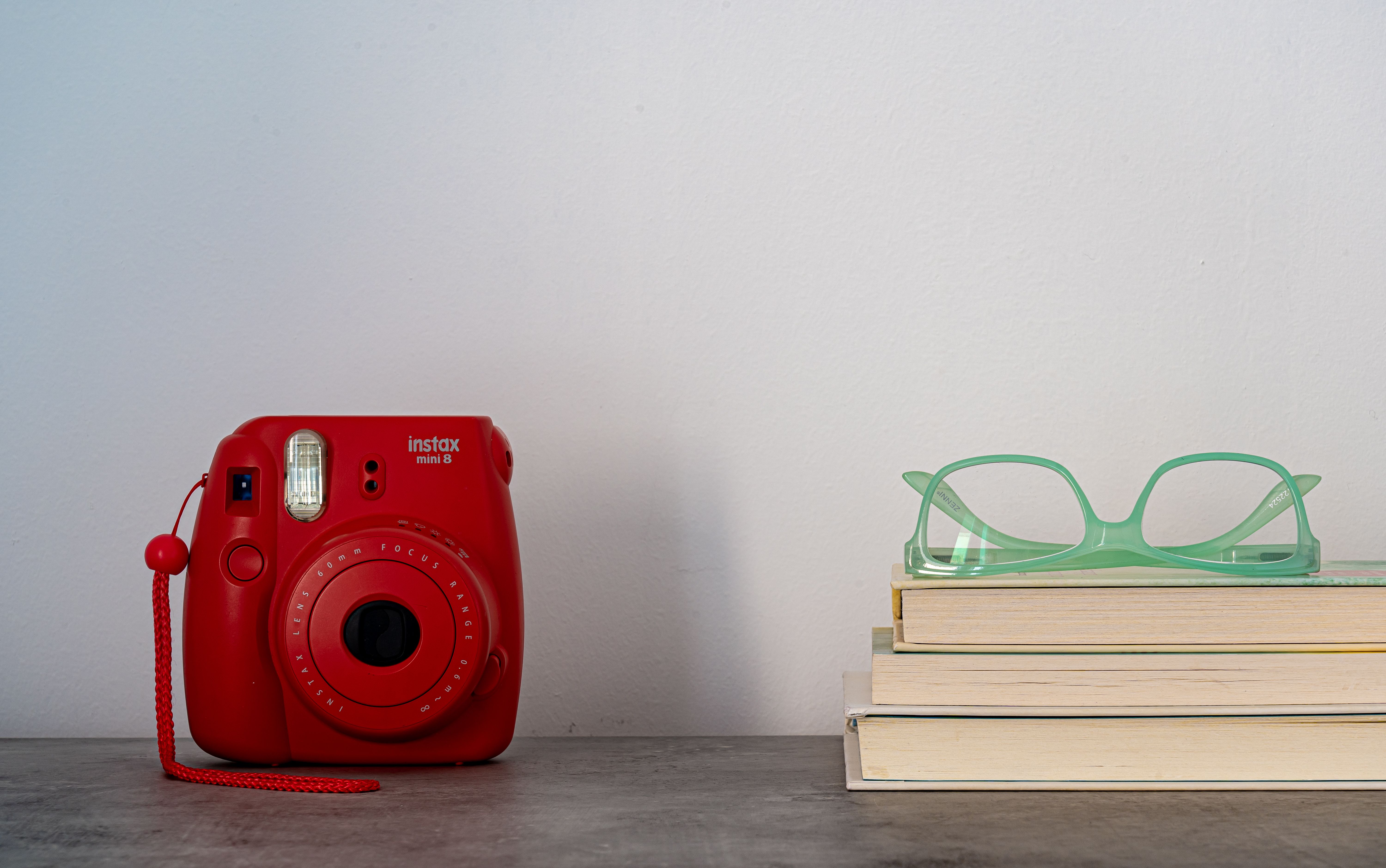Instax Camera Beside Books And Eyeglasses · Free Stock Photo