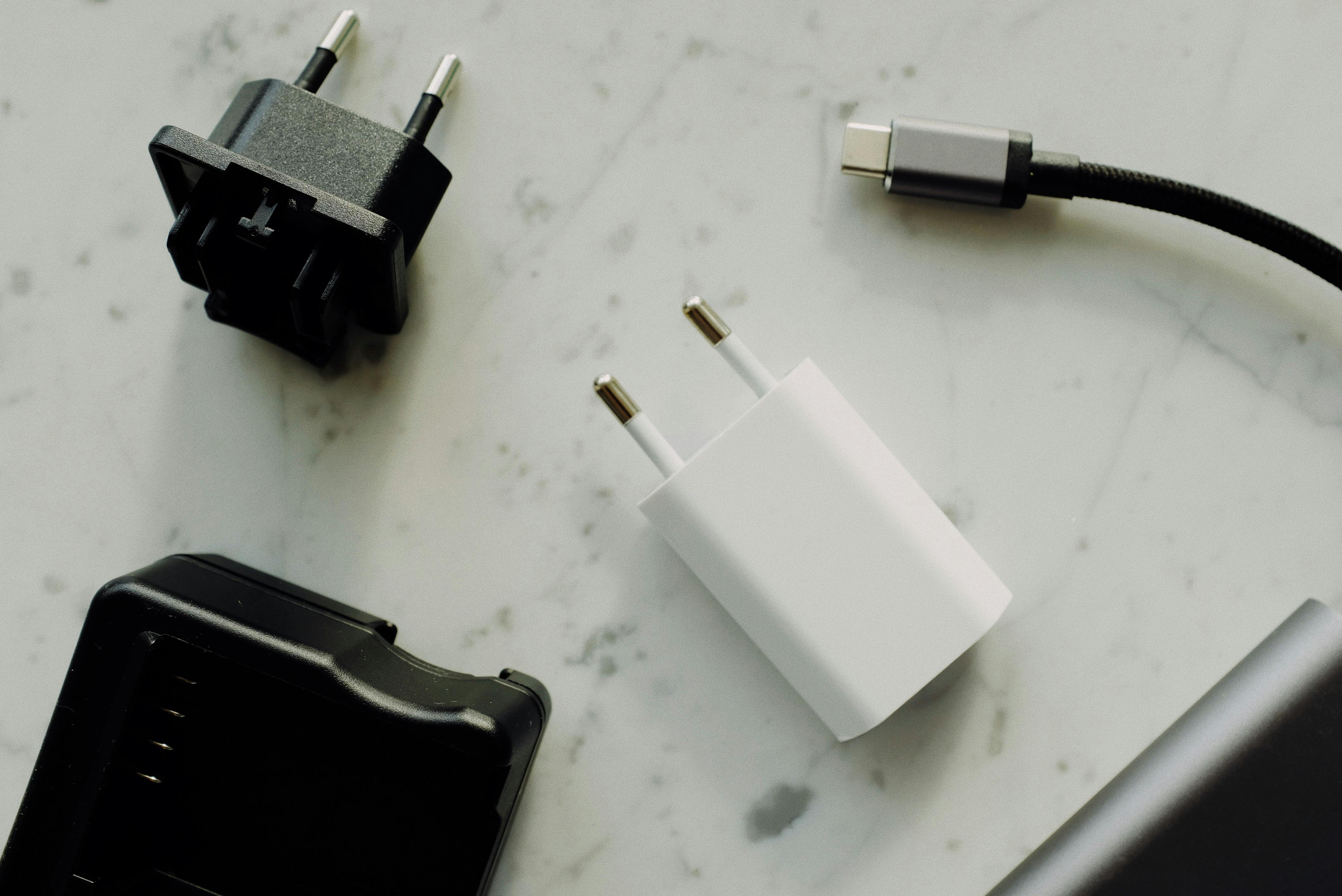 White And Black Adapter On White Surface · Free Stock Photo