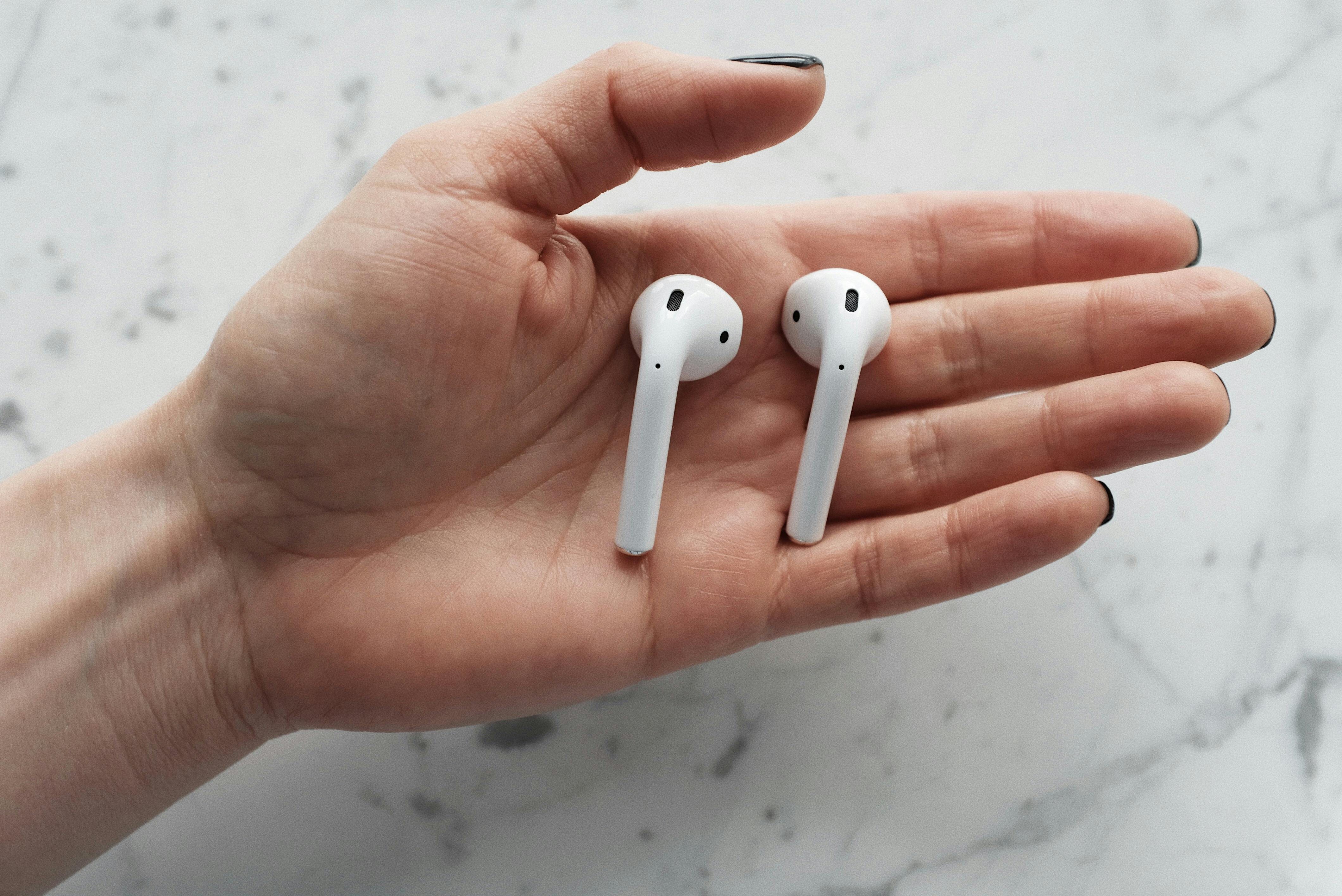 Person Holding Apple AirPods · Free Stock Photo Person Holding Apple AirPods · Free Stock Photo