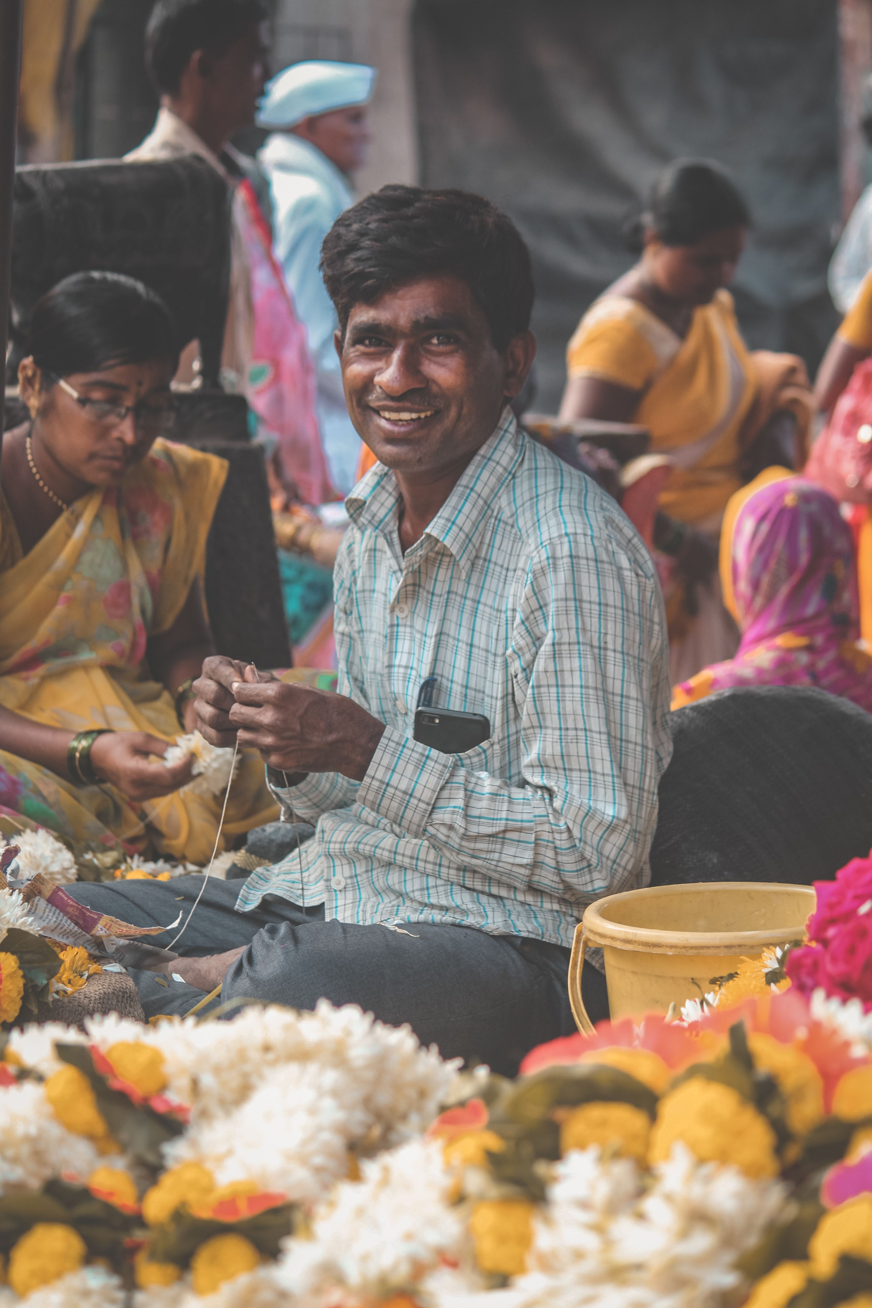 Indian man making floral garlands · Free Stock Photo