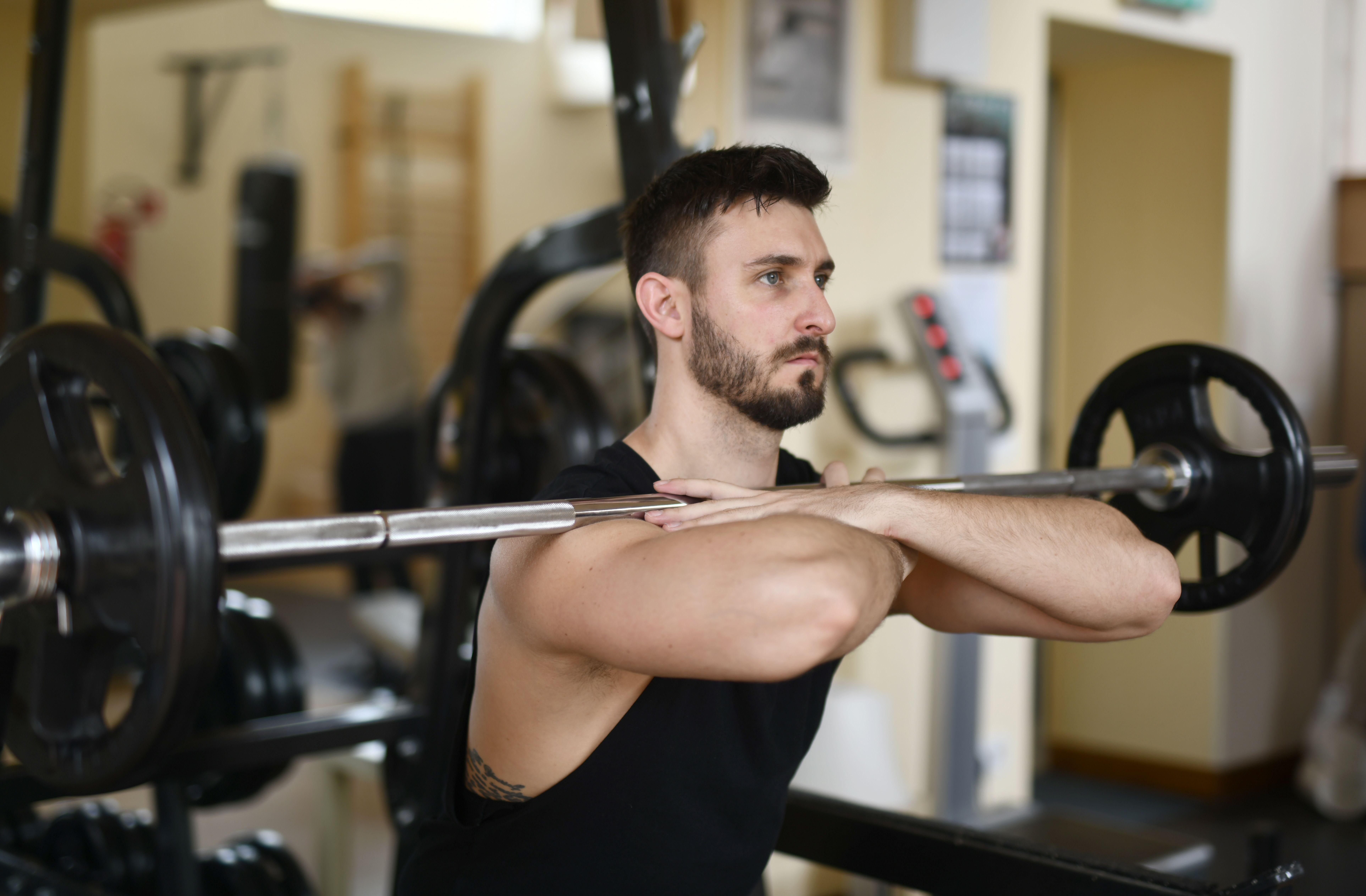 Photography of Man Carrying Ez Barbell · Free Stock Photo