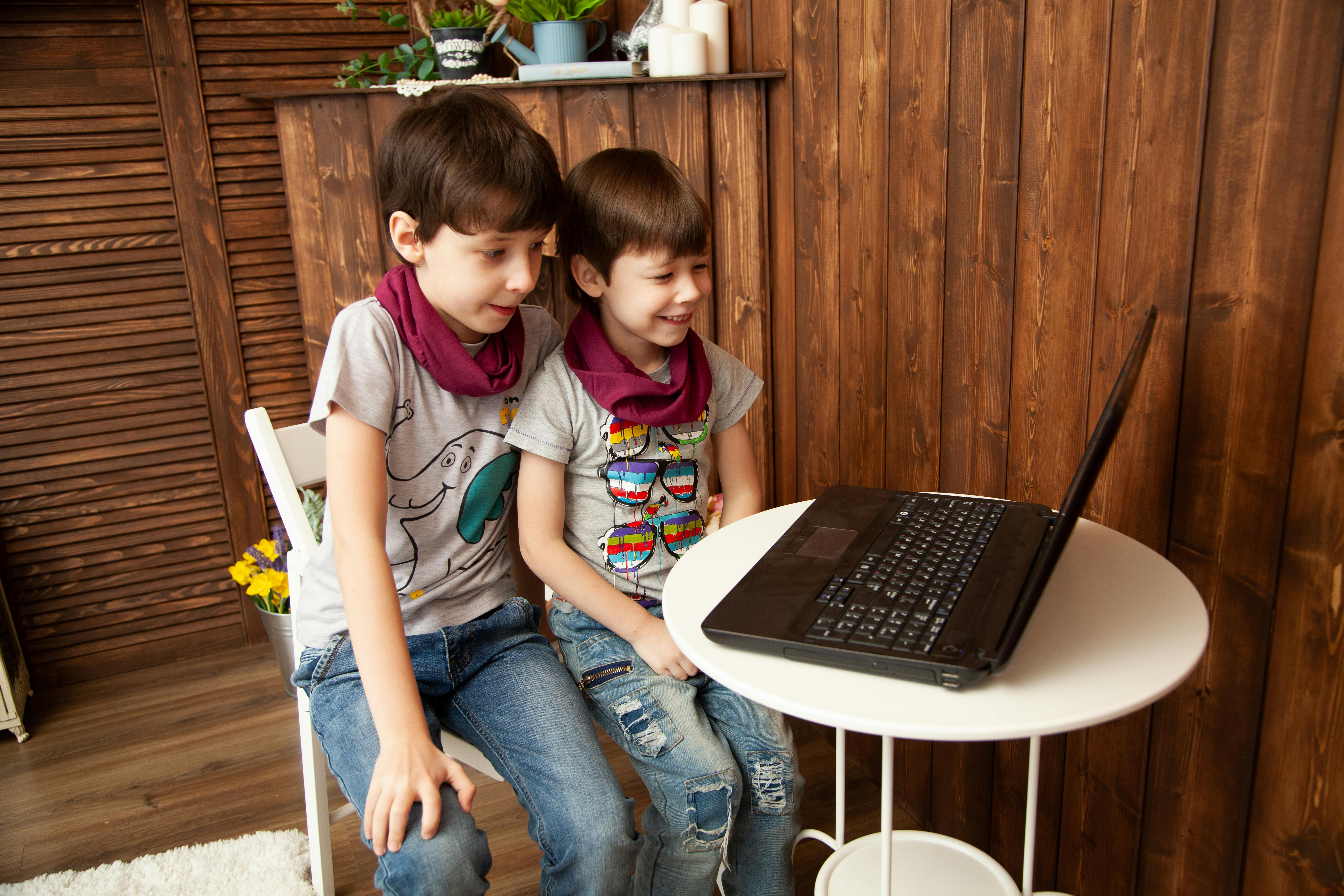 Boy Wearing Blue T Shirt Using Black Laptop Computer in a Dim Lighted ...