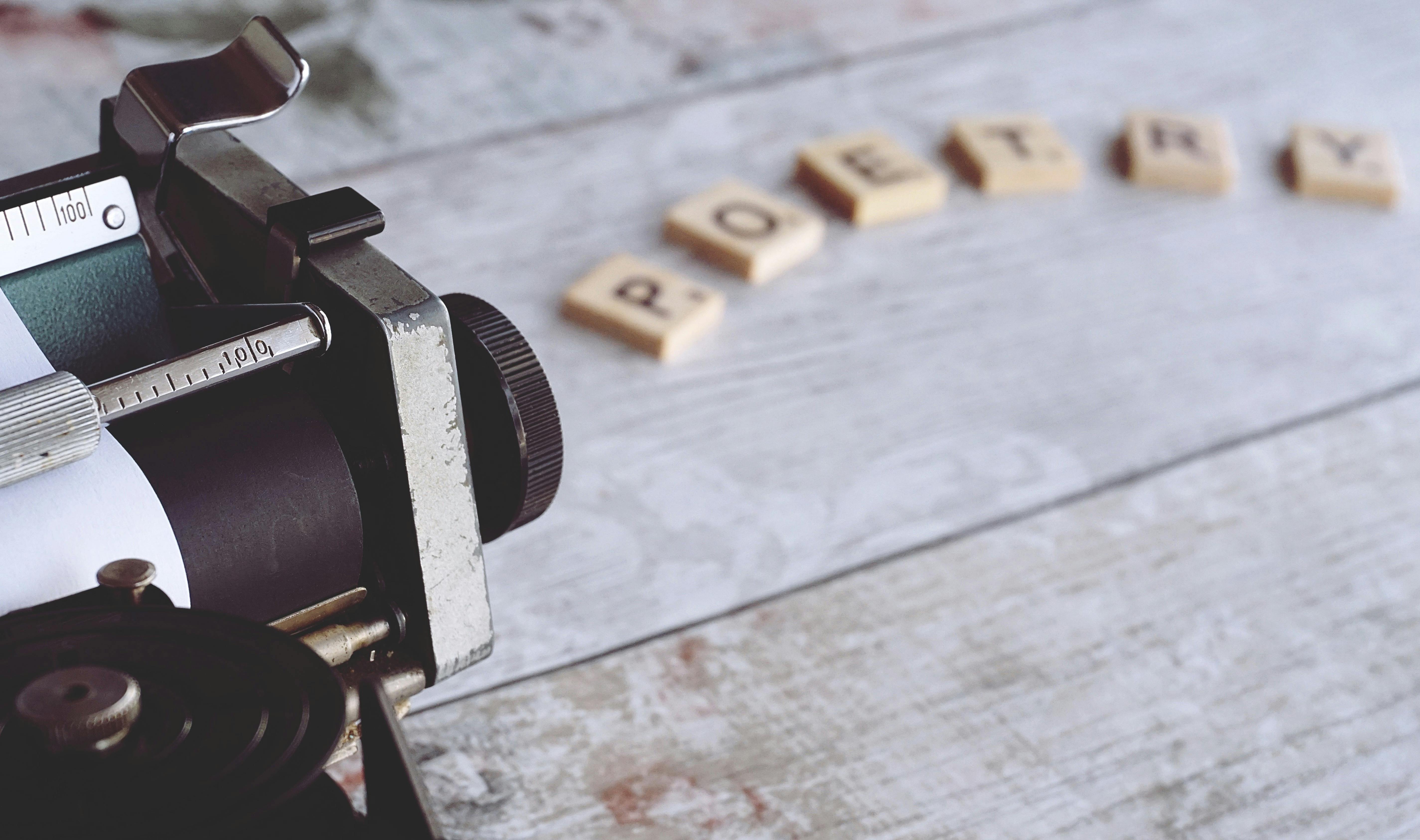 Scrabble Tiles Near a Typewriter · Free Stock Photo