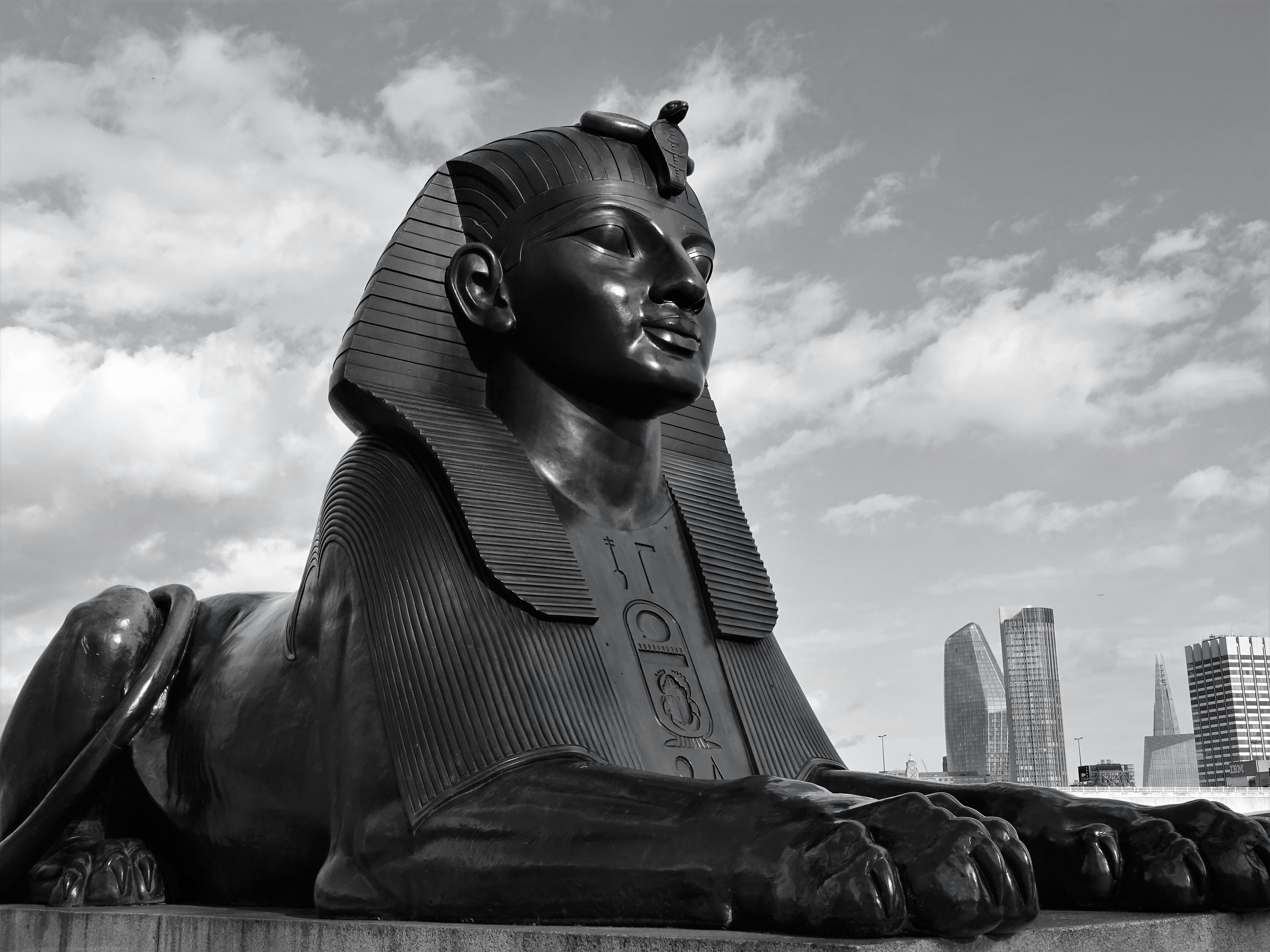 Sphinx statue near modern city · Free Stock Photo