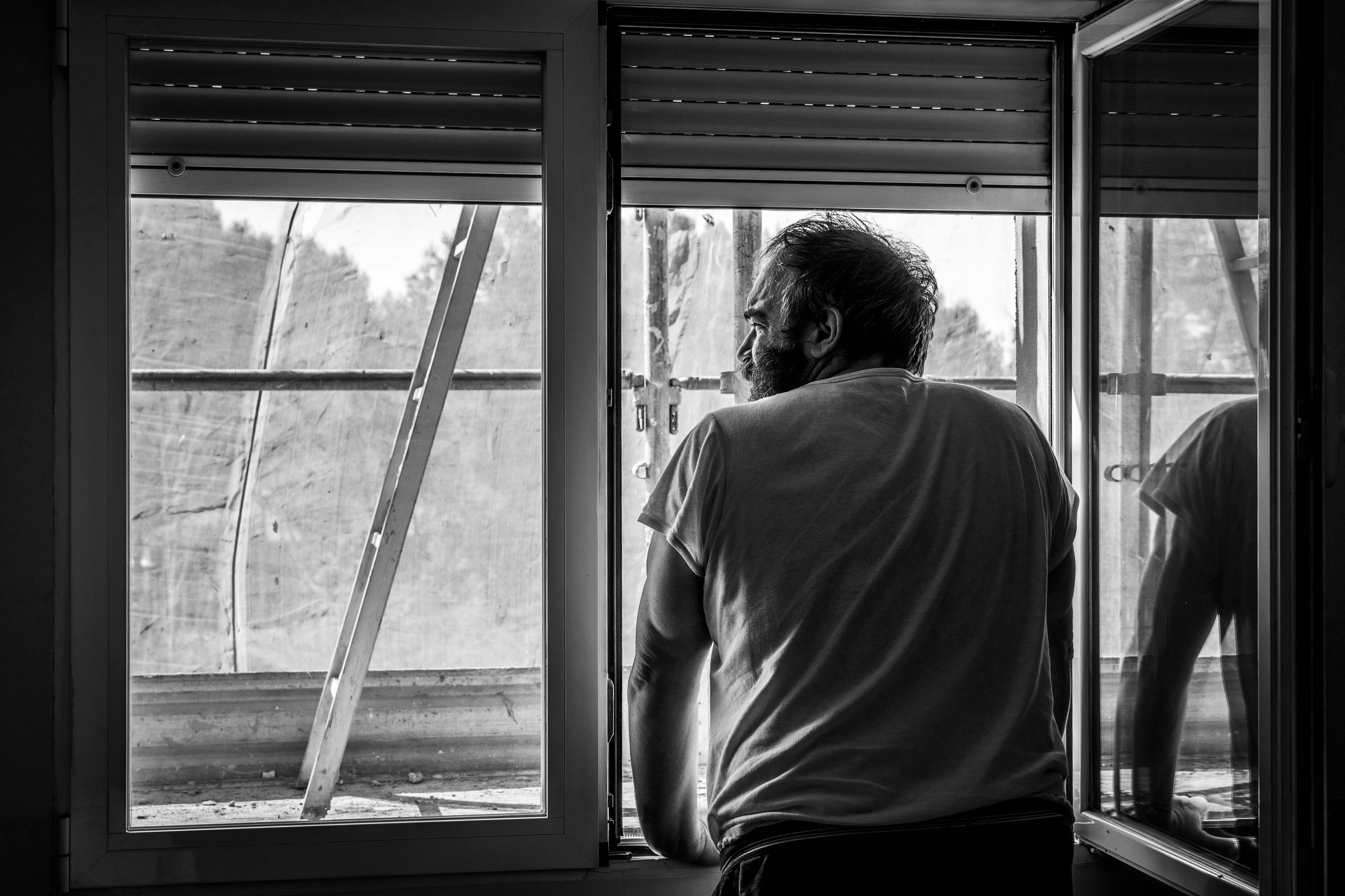 Man Standing Beside Window · Free Stock Photo