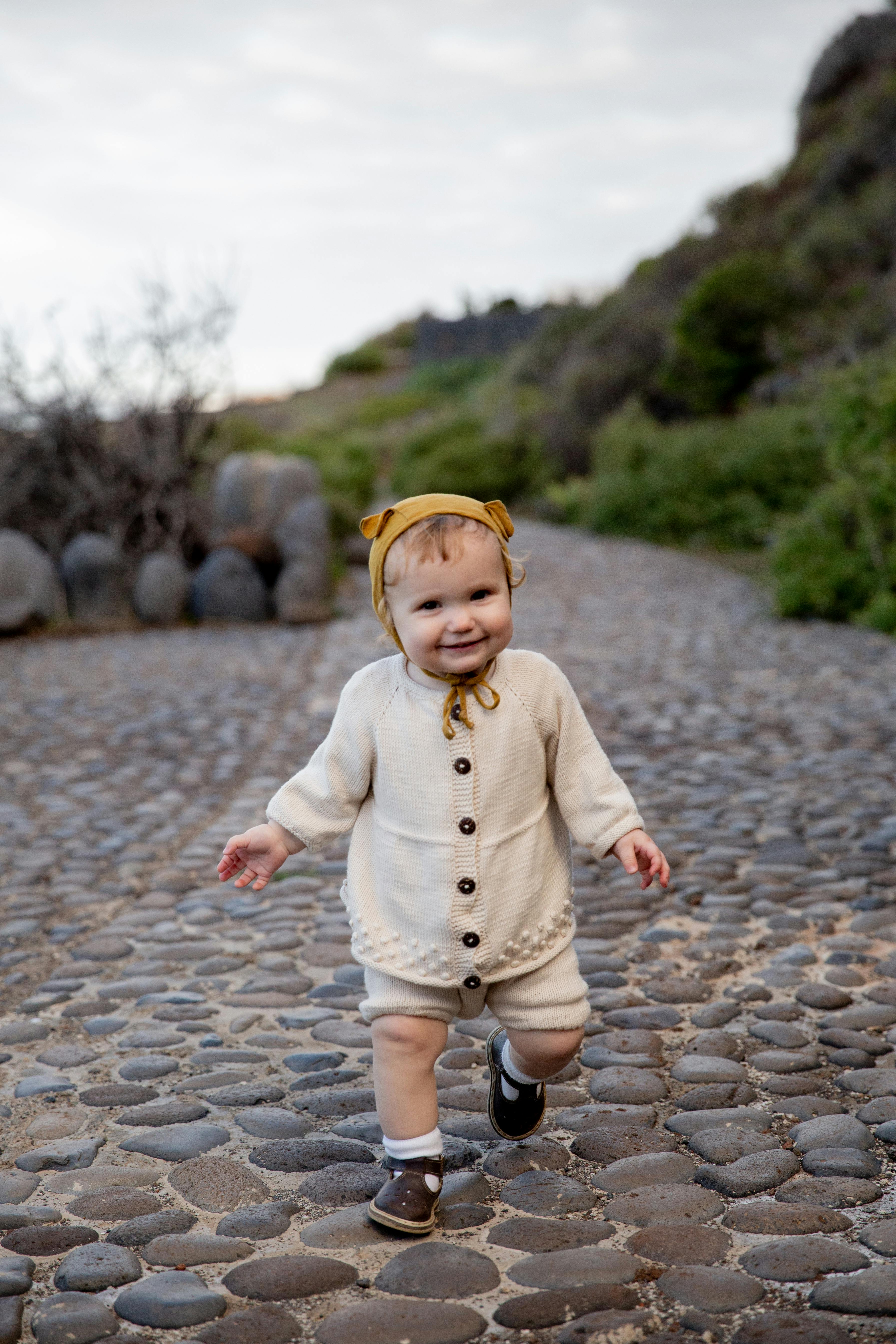 Cheerful cute little girl walking along stone path on nature · Free ...