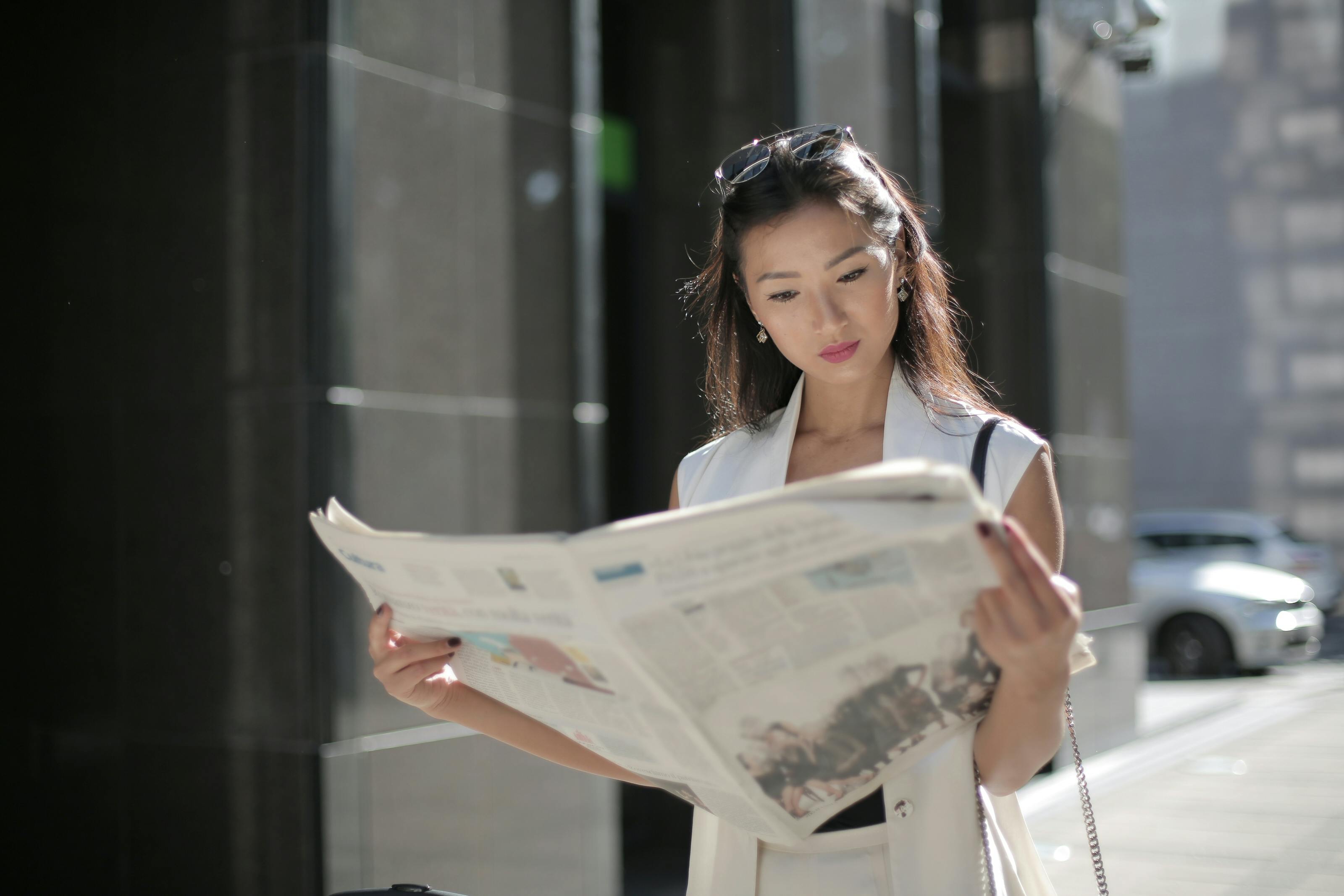 Photo Of Woman Holding Newspaper · Free Stock Photo