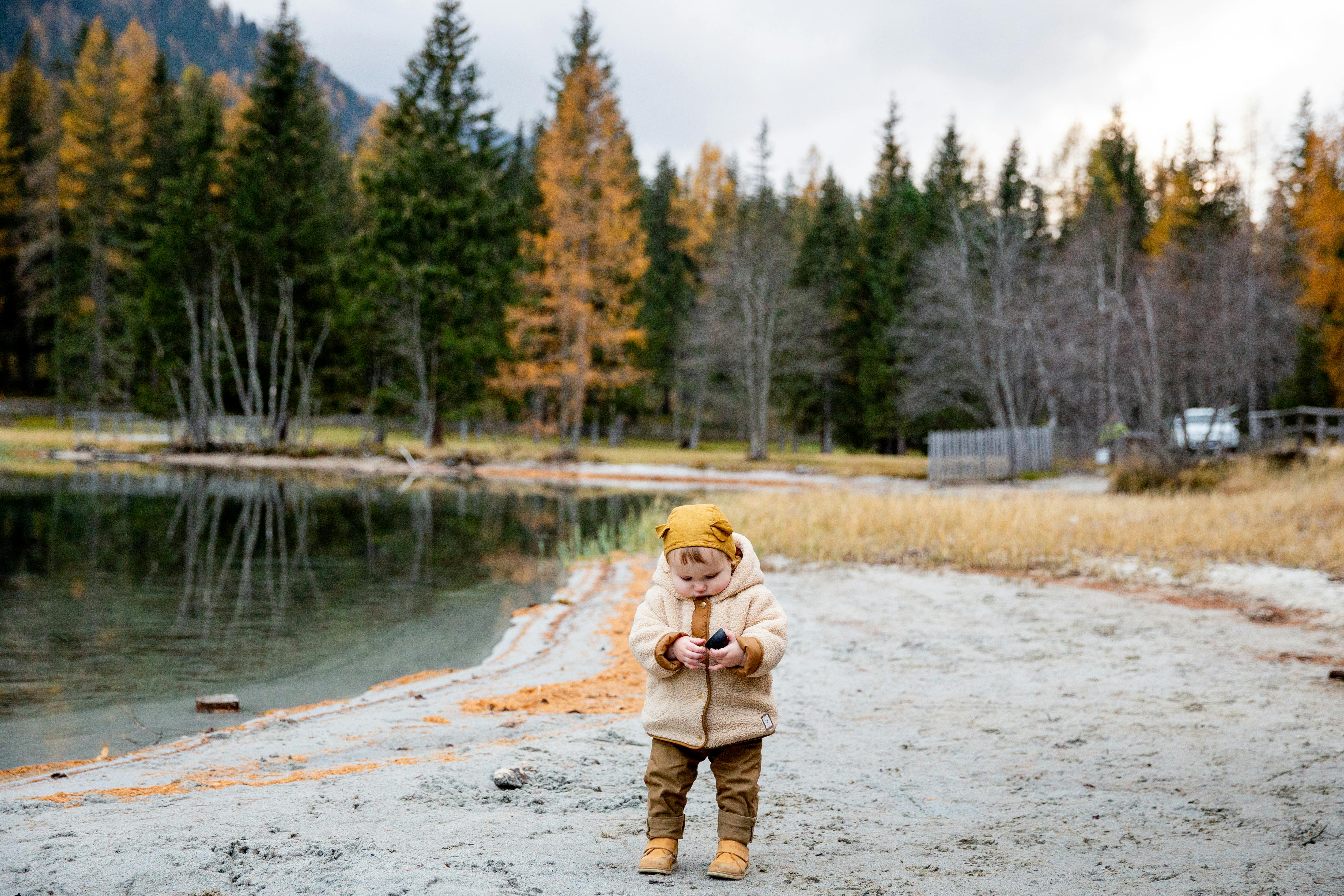 Photo Of Baby Near Lake · Free Stock Photo