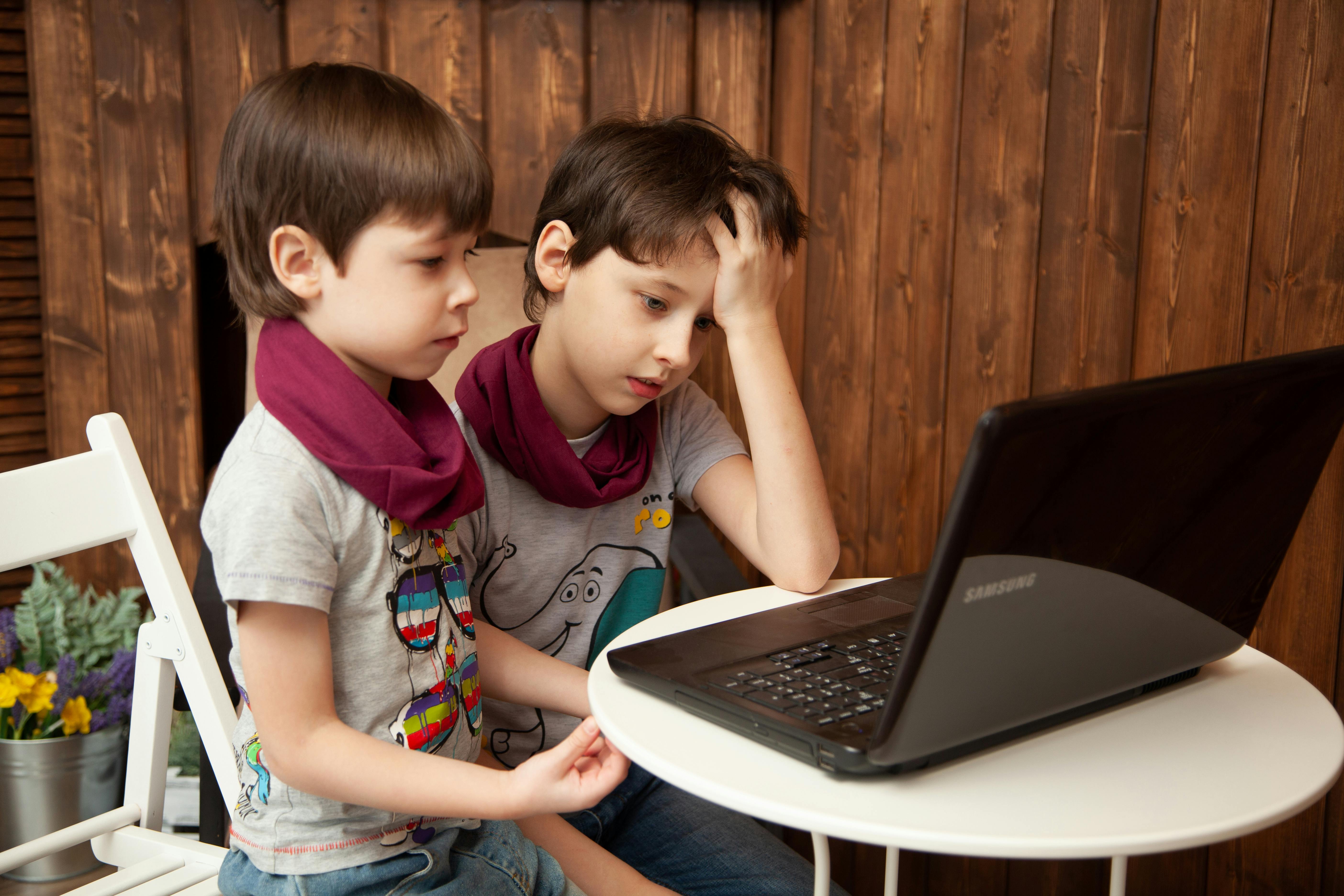 Boy Wearing Blue T Shirt Using Black Laptop Computer in a Dim Lighted ...