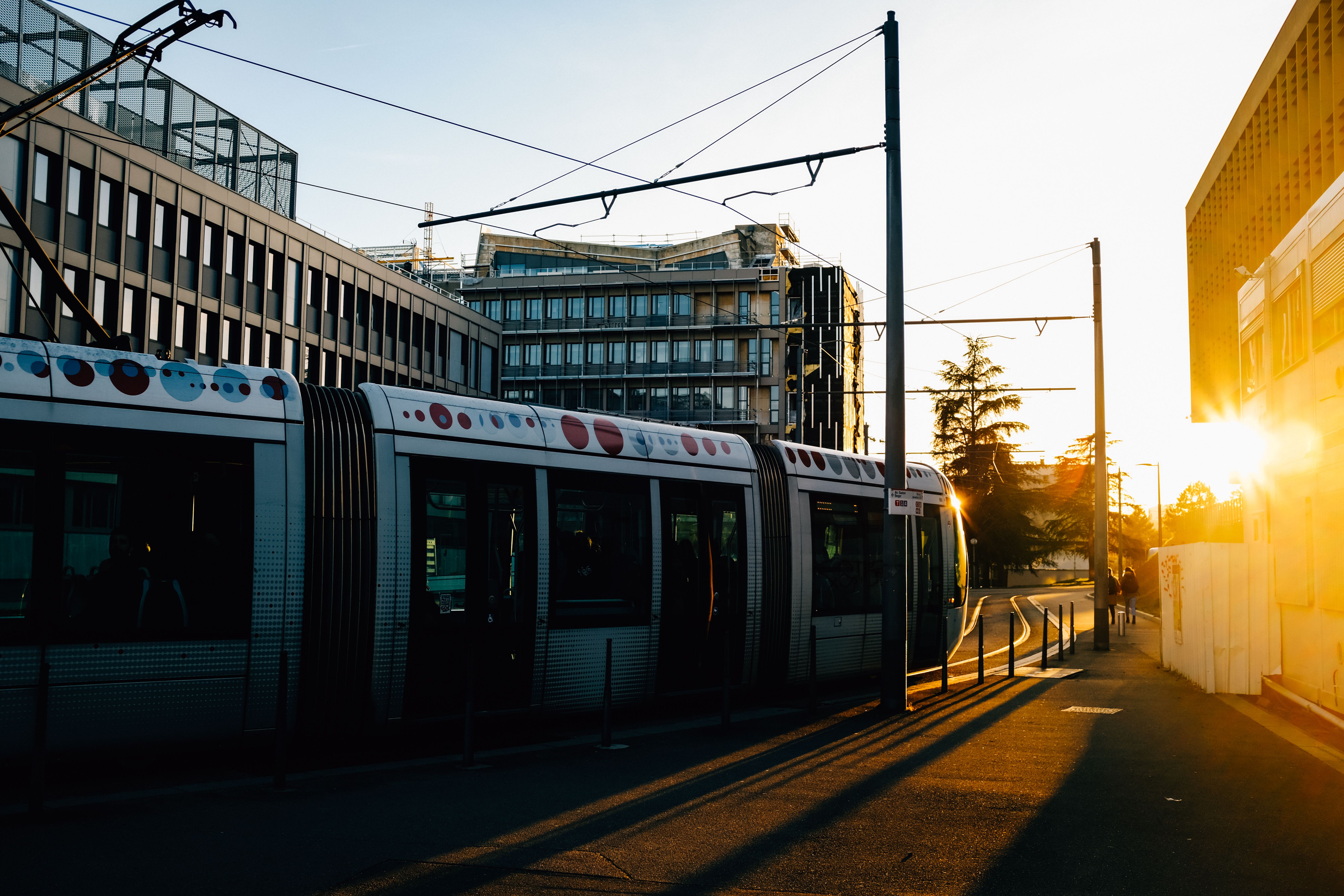Tram riding on city street in evening time · Free Stock Photo