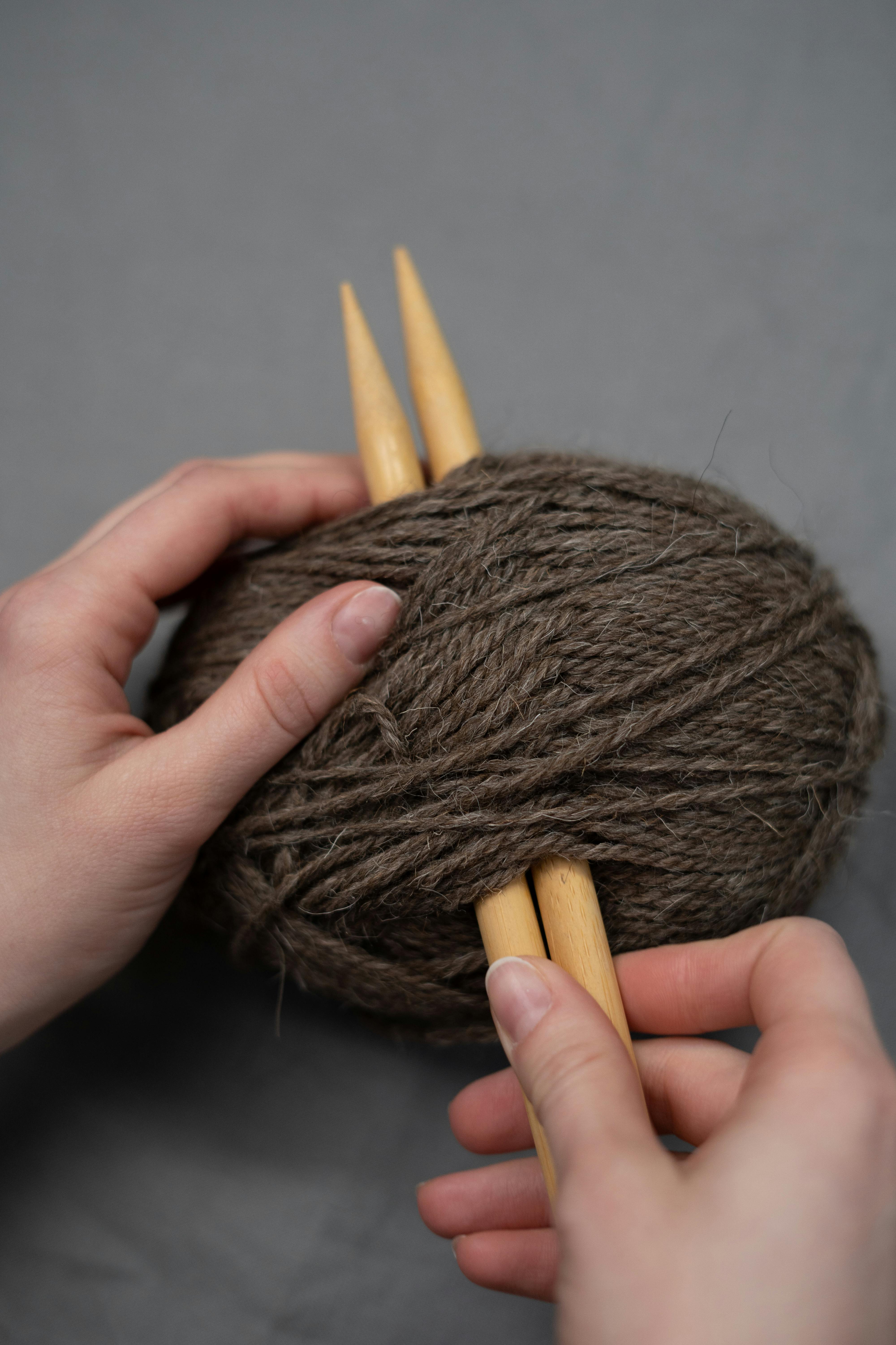 Person Holding Brown Yarn Roll · Free Stock Photo