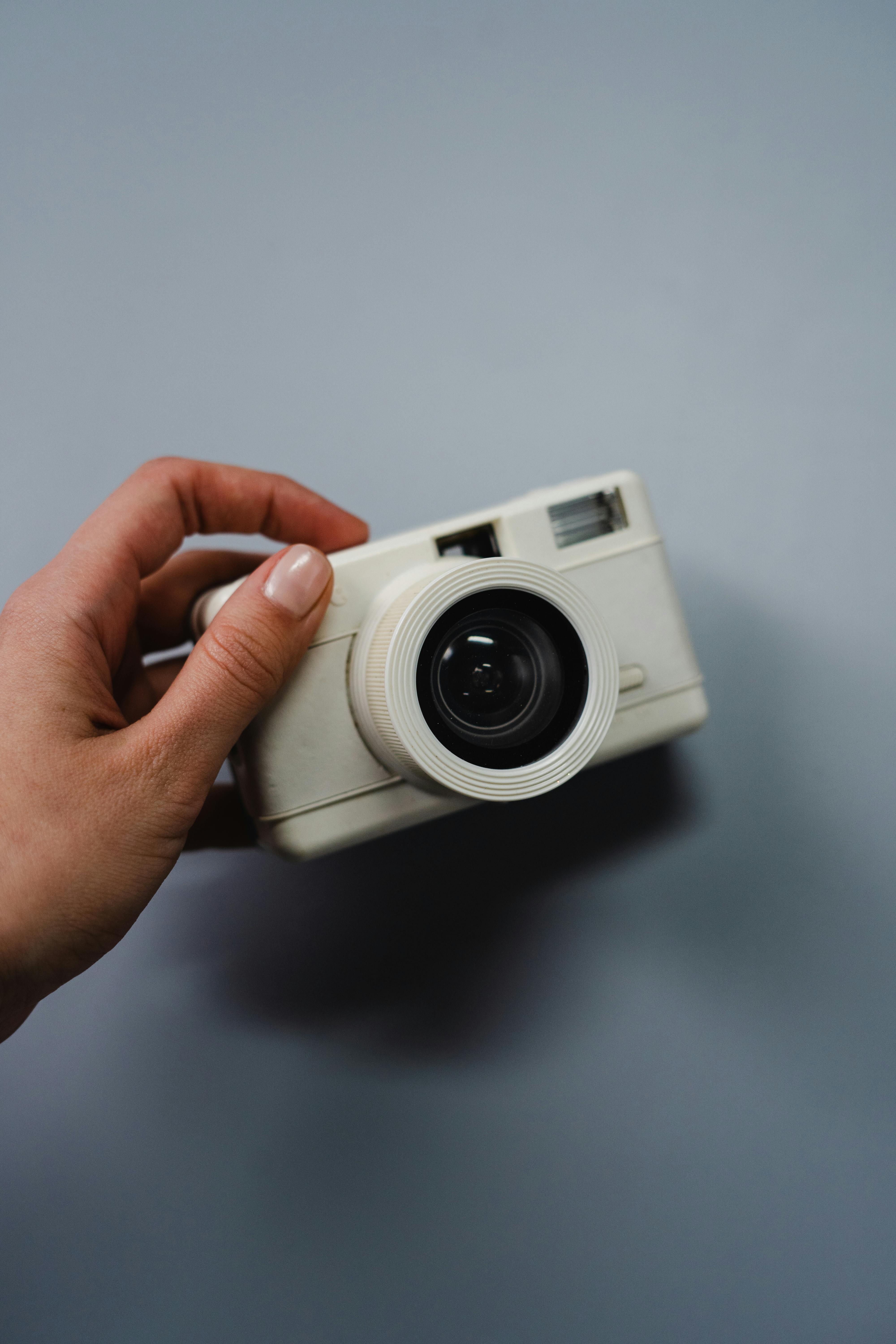 Person Holding White Camera · Free Stock Photo