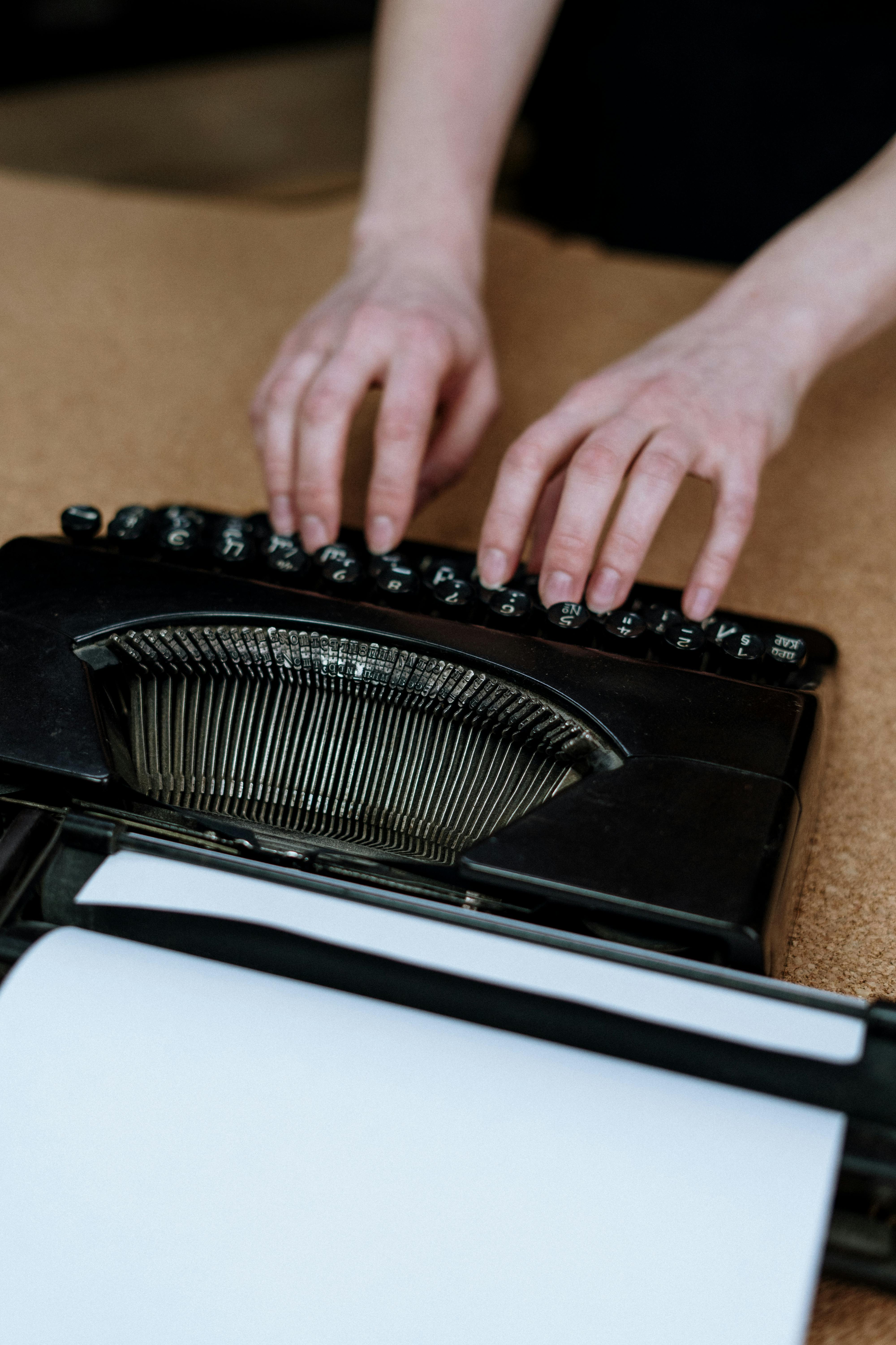 Persons Hand on Black and White Braille Machine · Free Stock Photo
