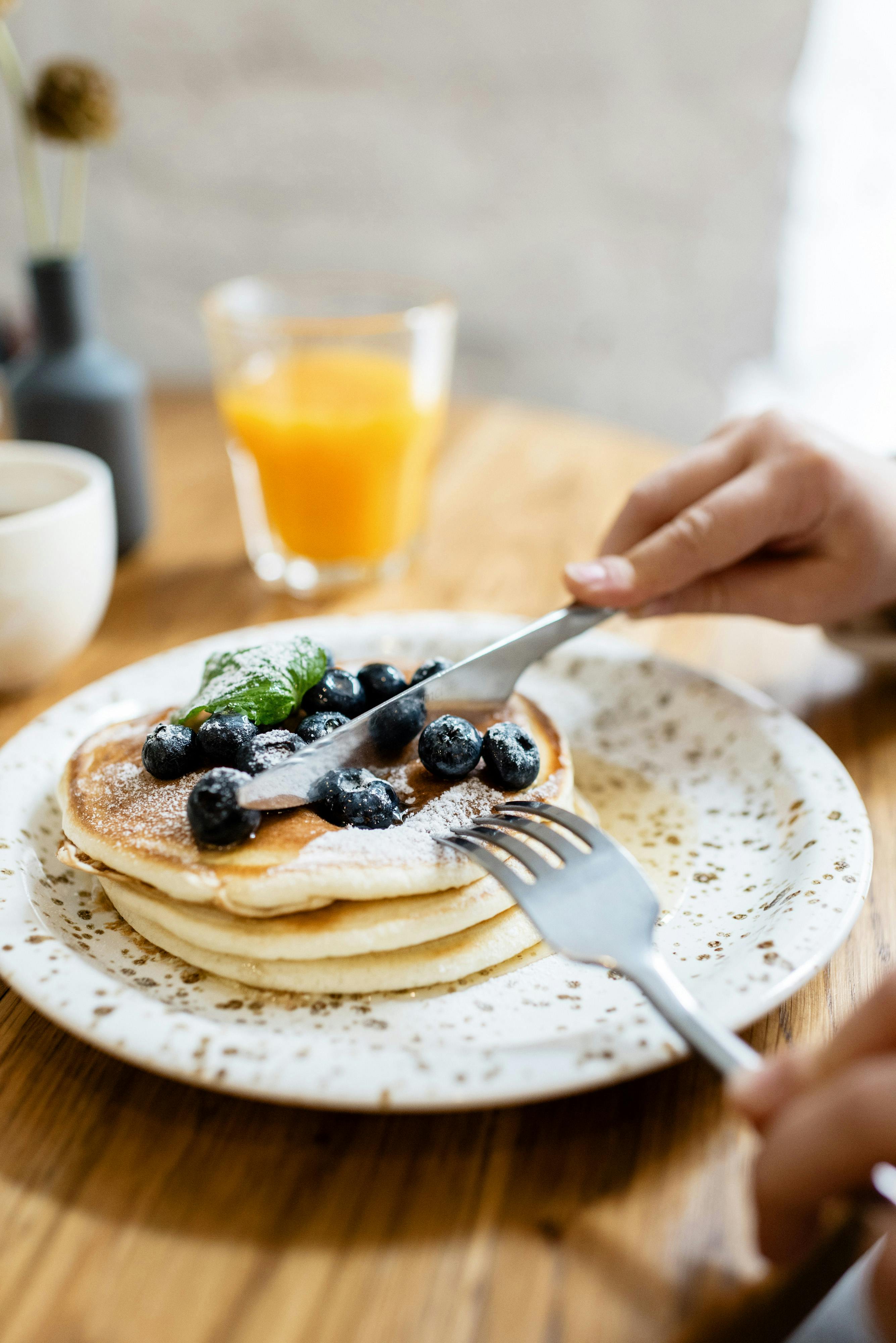 Person Slicing A Pancake · Free Stock Photo
