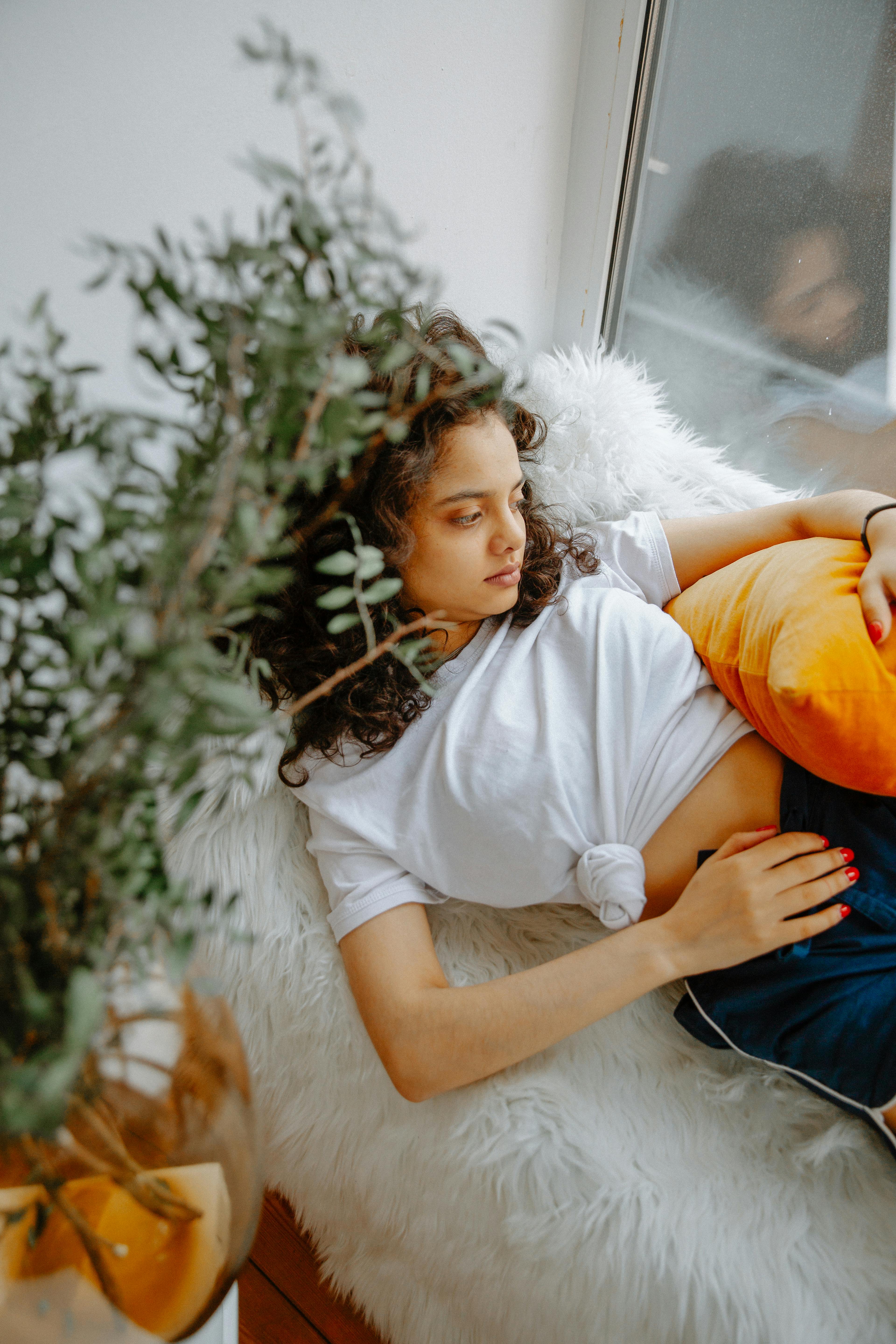 Woman Curled Up on Floor · Free Stock Photo