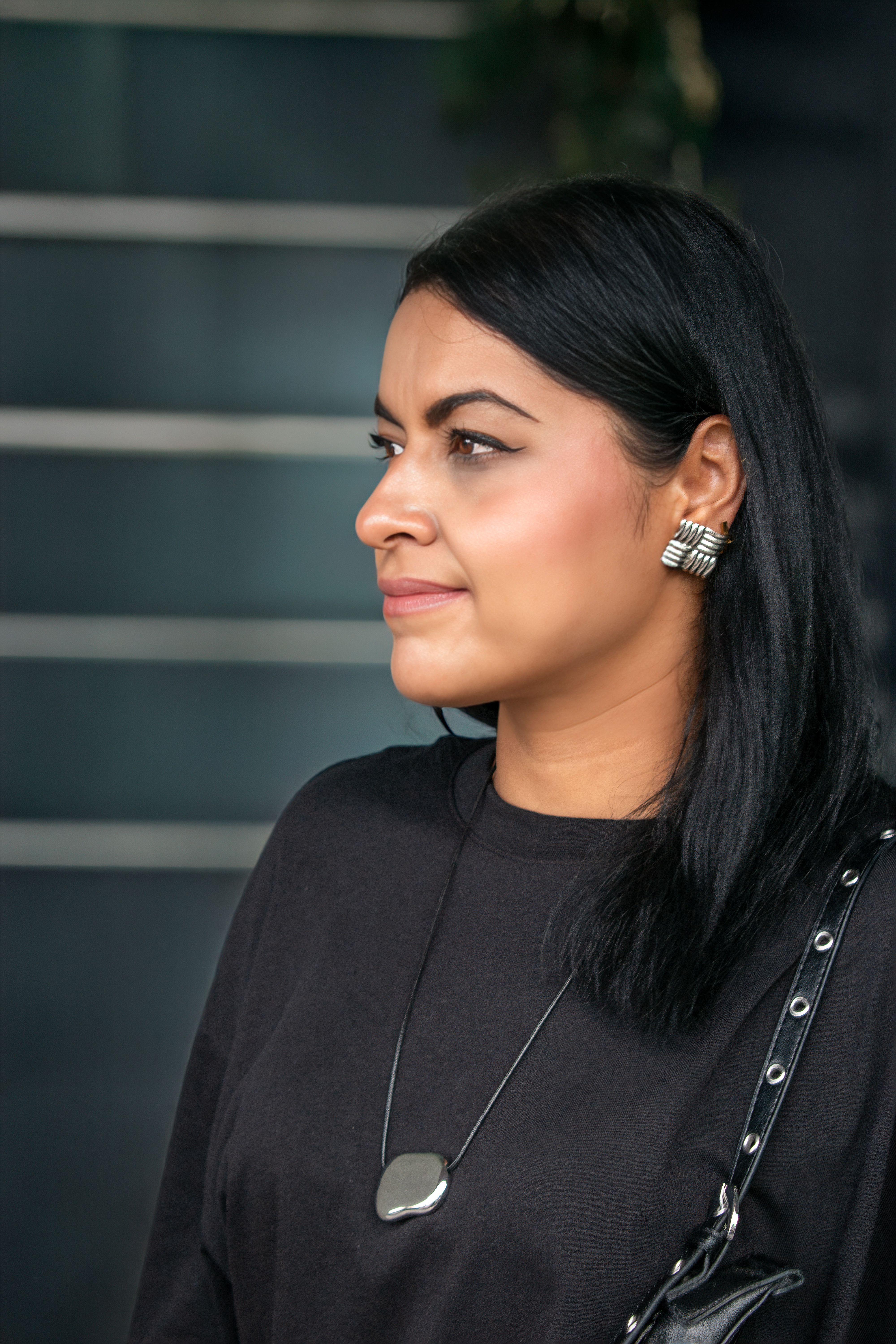 Profile Portrait of a Thoughtful Woman in Black · Free Stock Photo