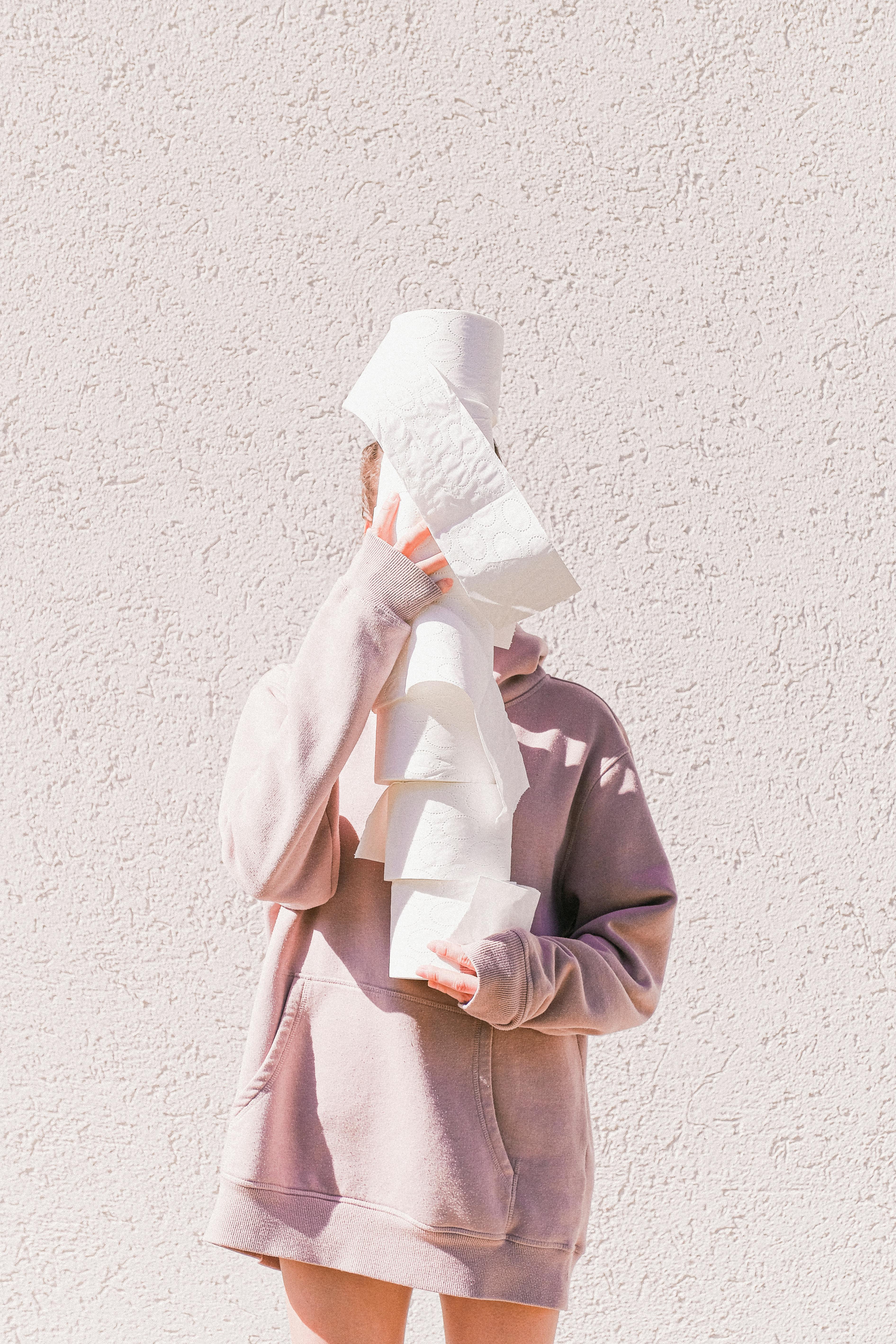 Person Carrying Tissue Rolls · Free Stock Photo