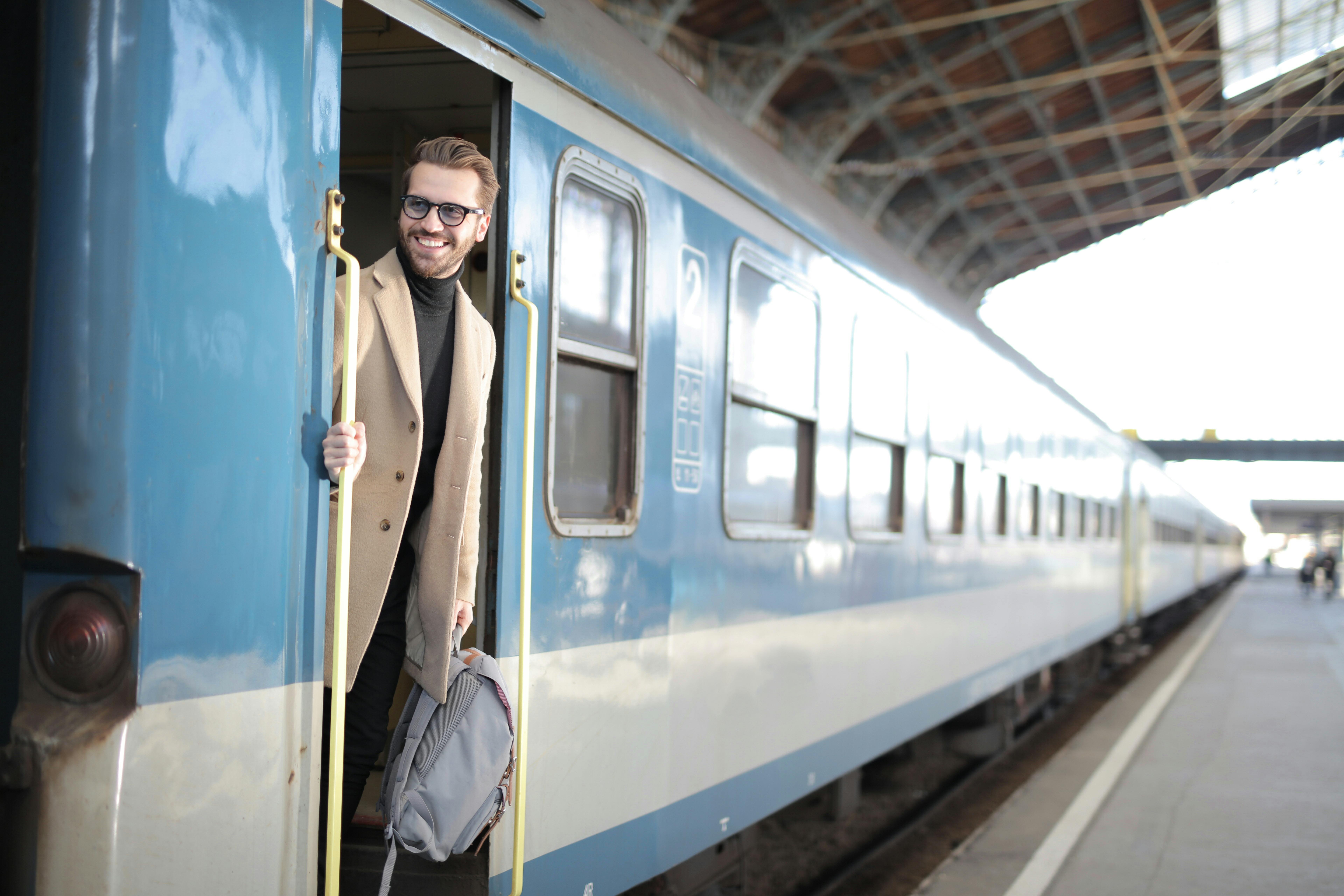 Man Smiling Going Out the Train · Free Stock Photo