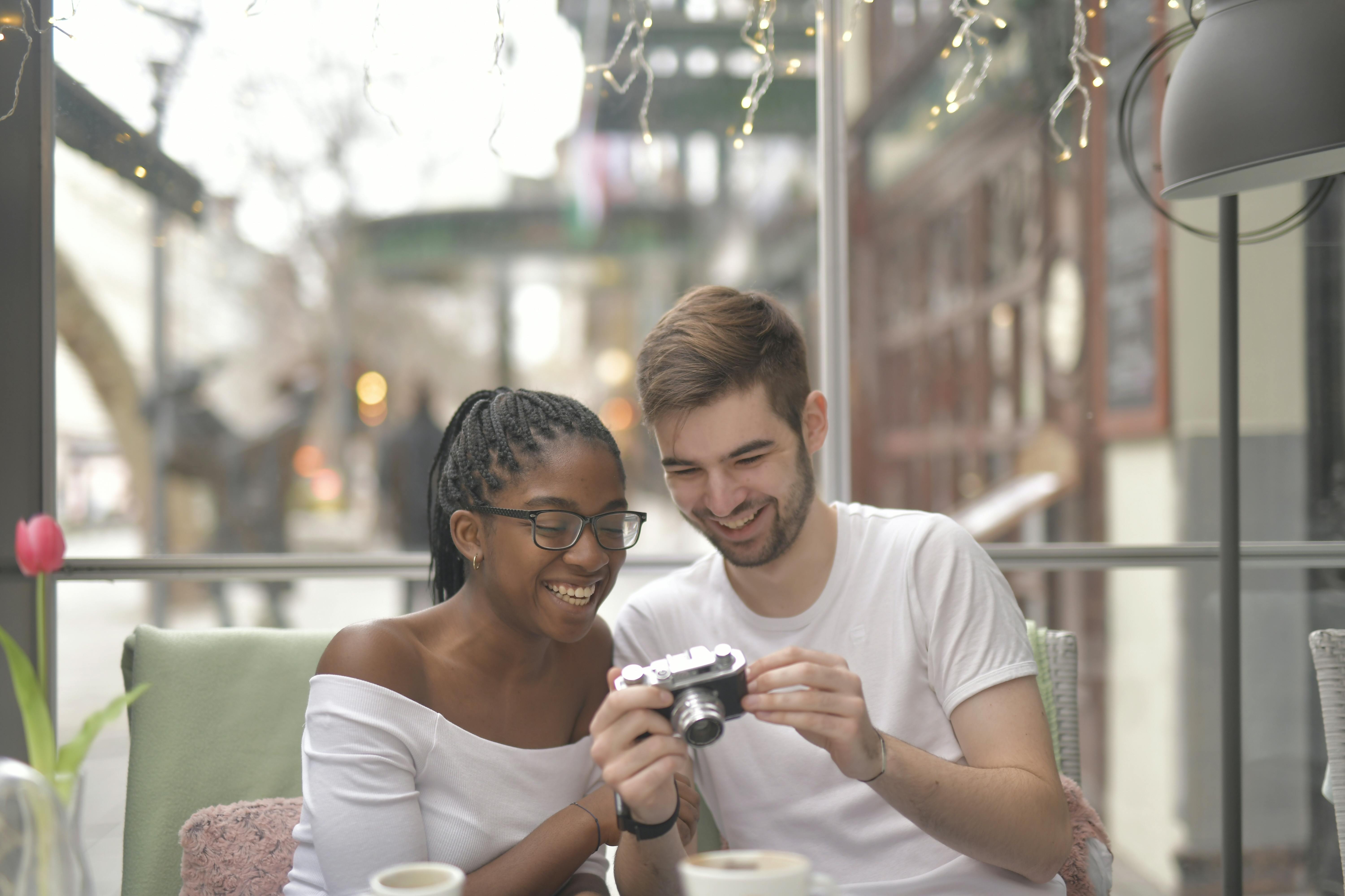 Couple Holding Camera Reminiscing Memories · Free Stock Photo