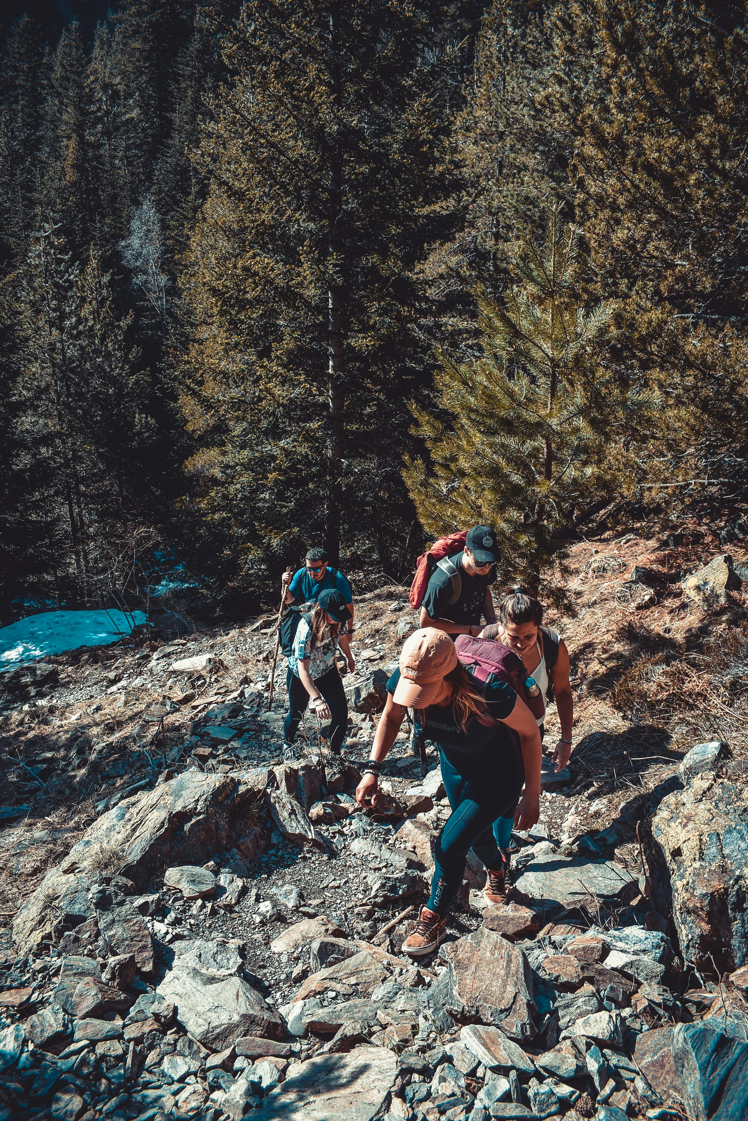 People Hiking On Rocky Mountain · Free Stock Photo