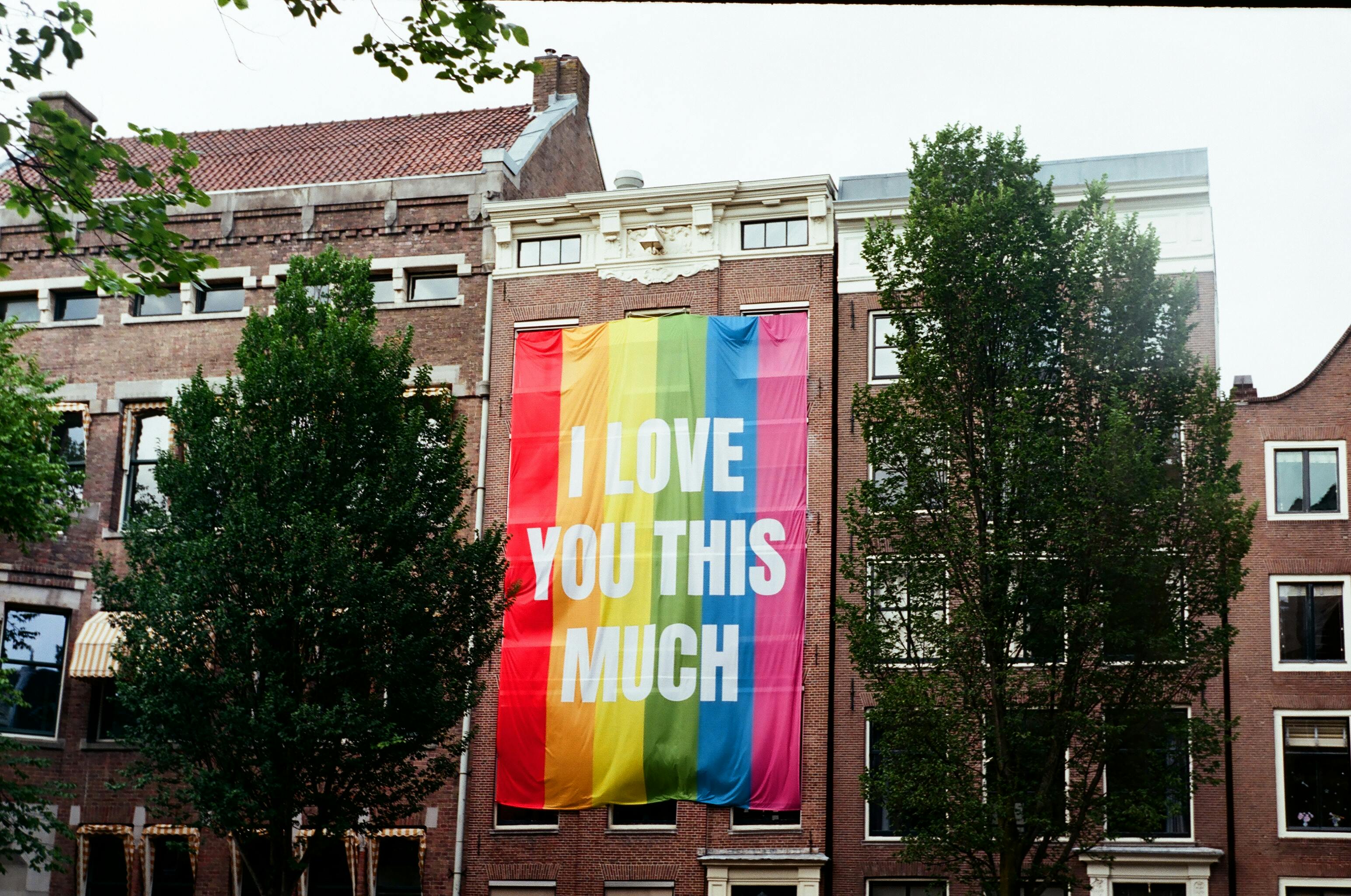 A Pride Flag Hanging on a Building · Free Stock Photo