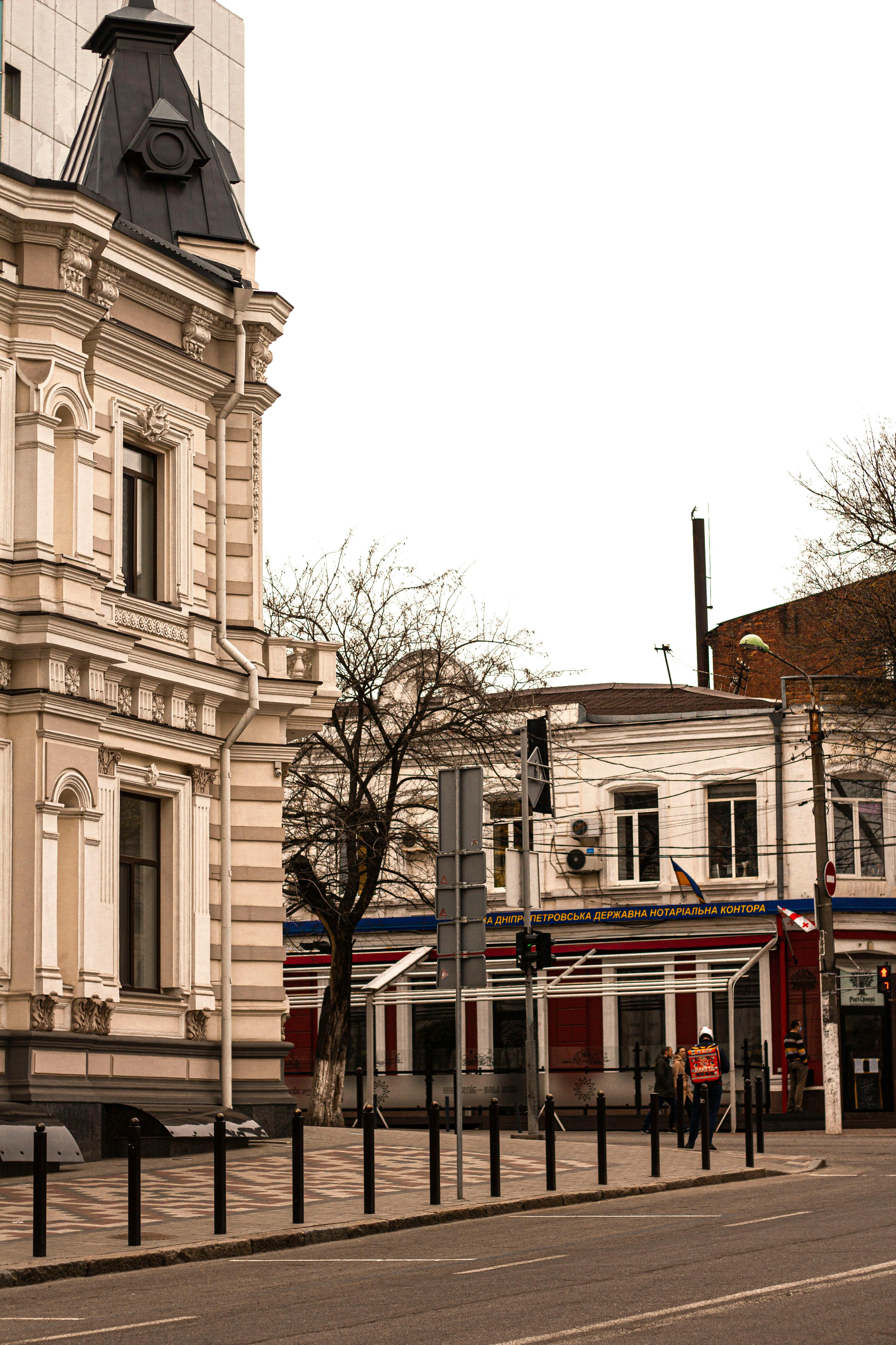 Black Asphalt Road Between Brown City Building Under White Skies during ...