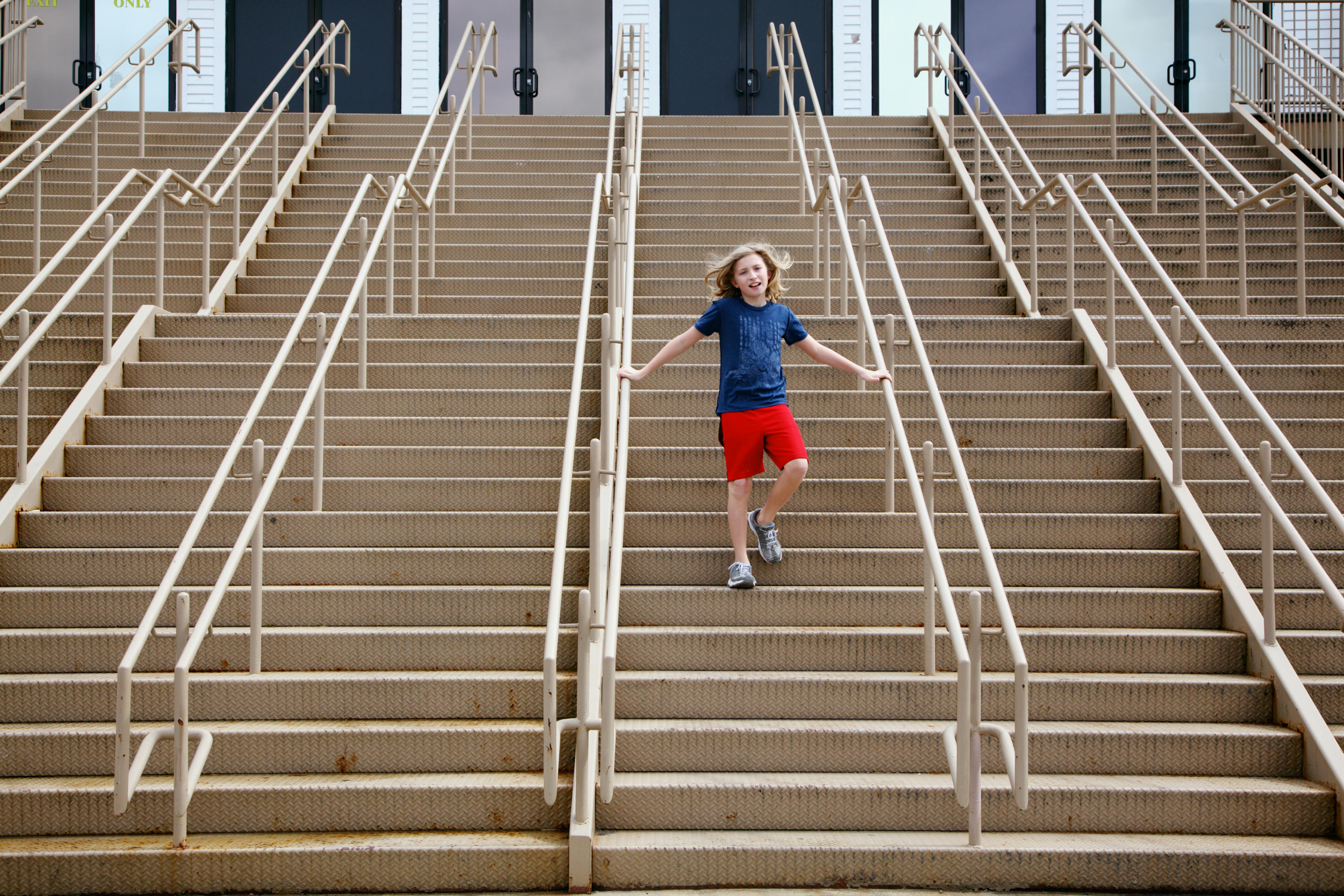 Close-Up Shot of a Boy Walking Down The Stairs · Free Stock Photo