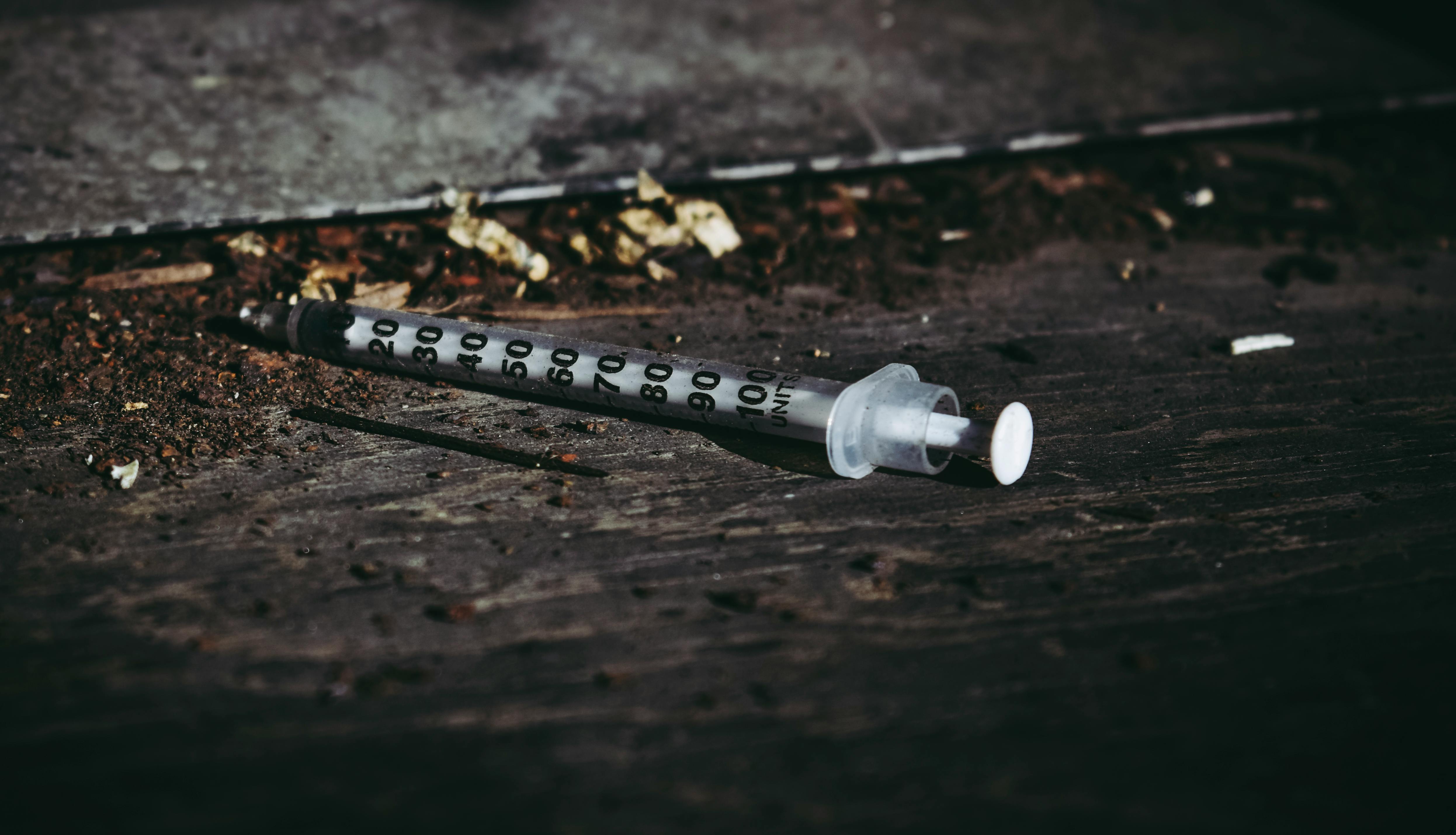 Syringe On Wooden Floor · Free Stock Photo