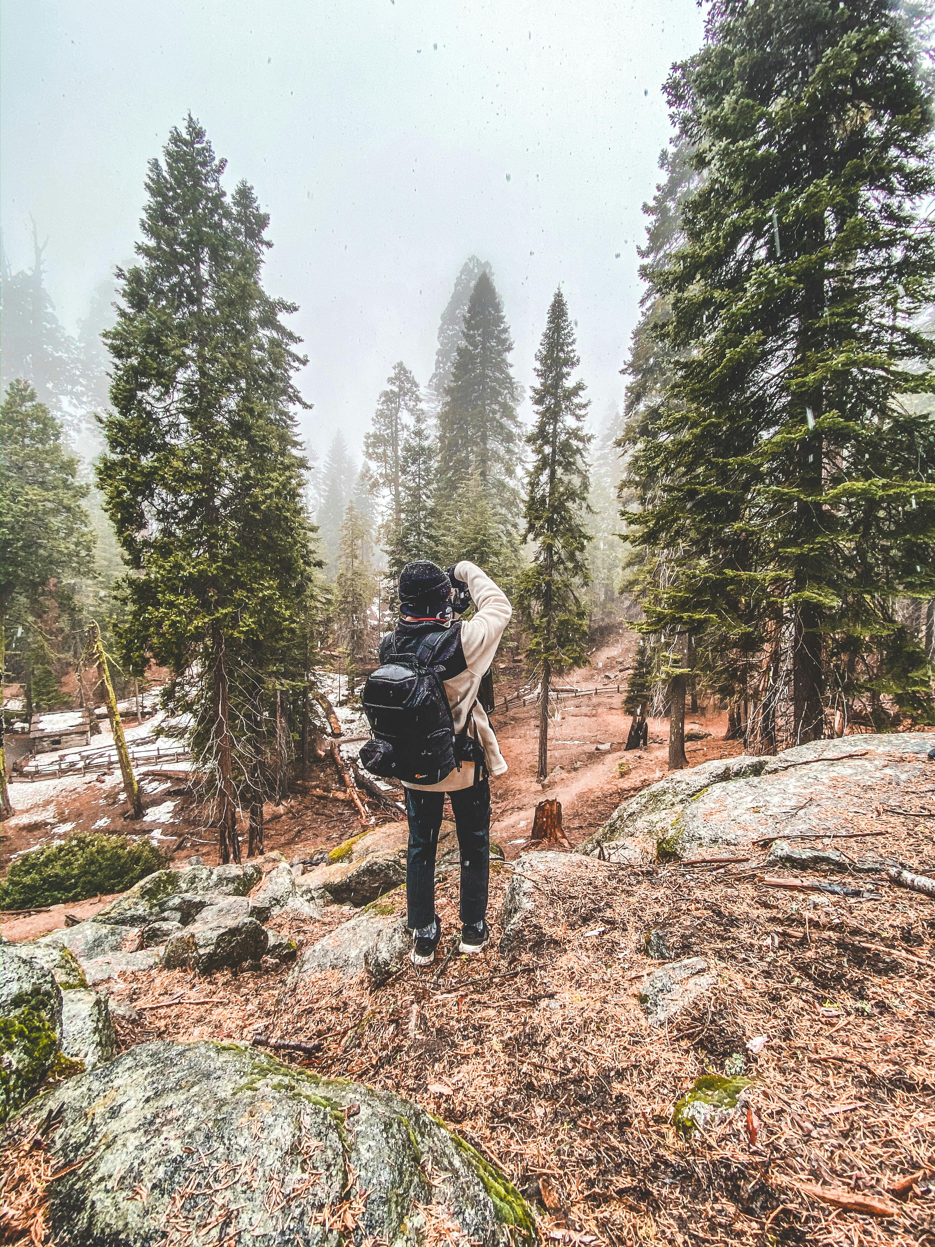 Man Carrying A Black Backpack Taking Photos · Free Stock Photo