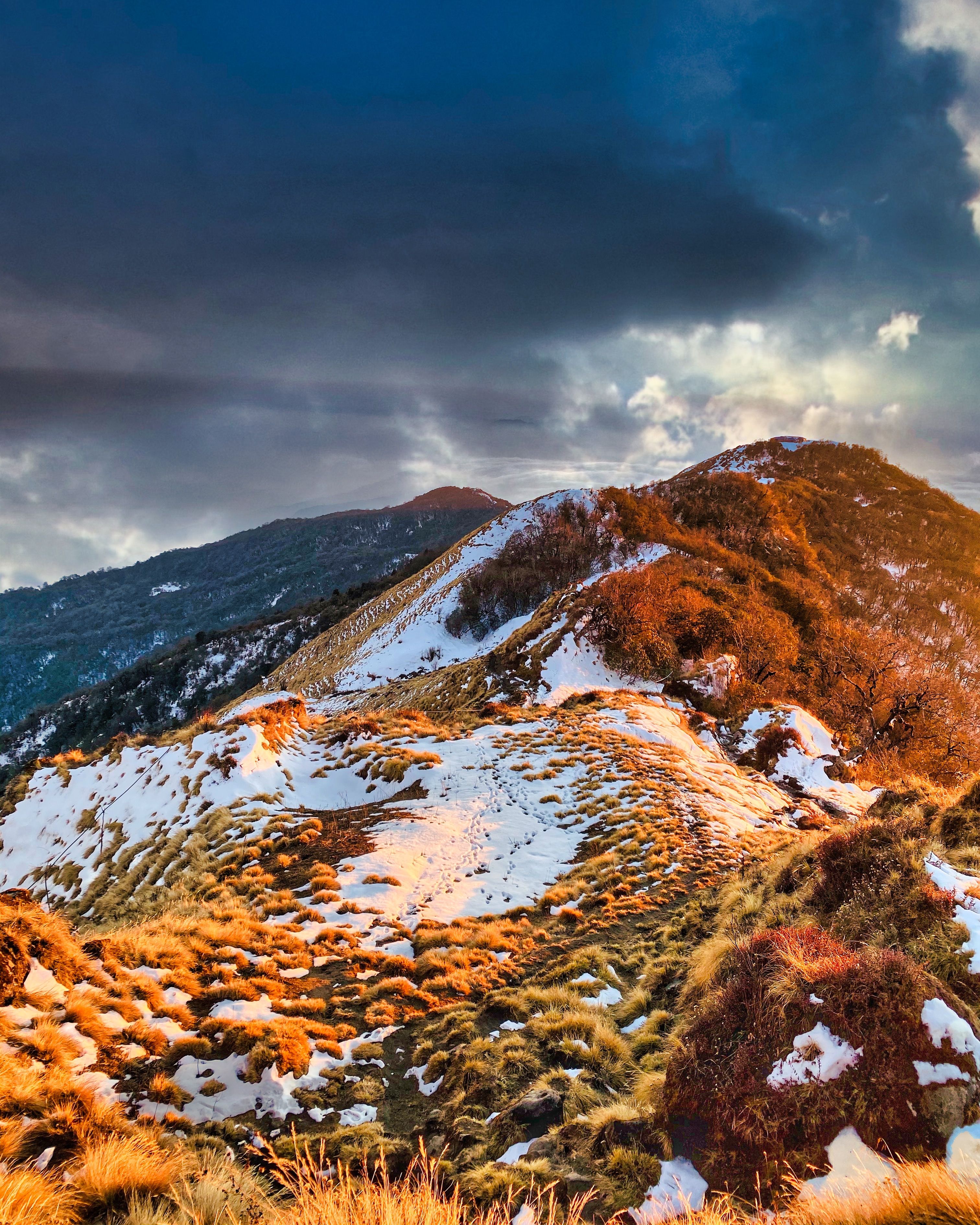 Snowy mountainous valley against cloudy sky · Free Stock Photo