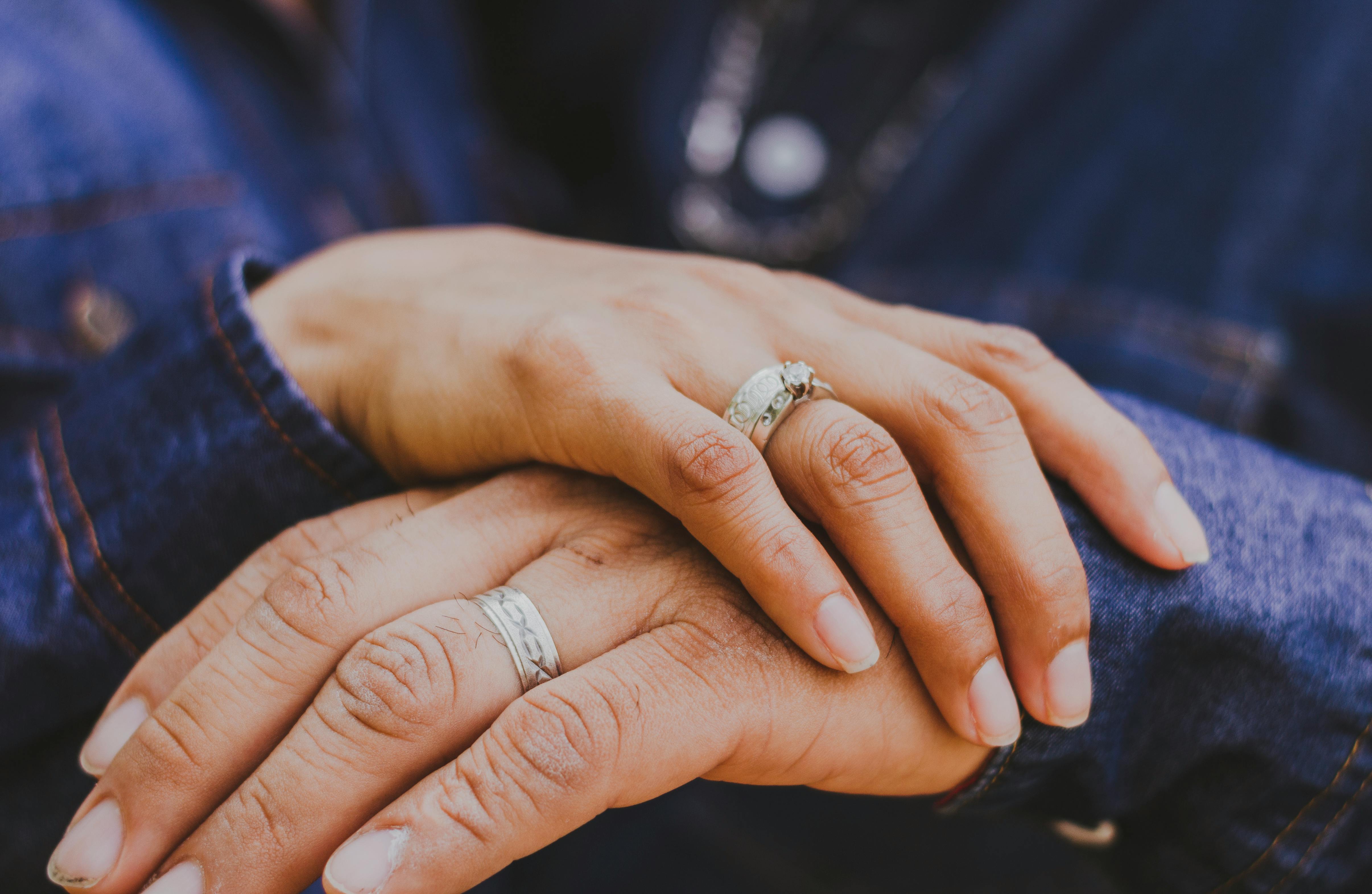 Crop unrecognizable couple holding hands gently · Free Stock Photo