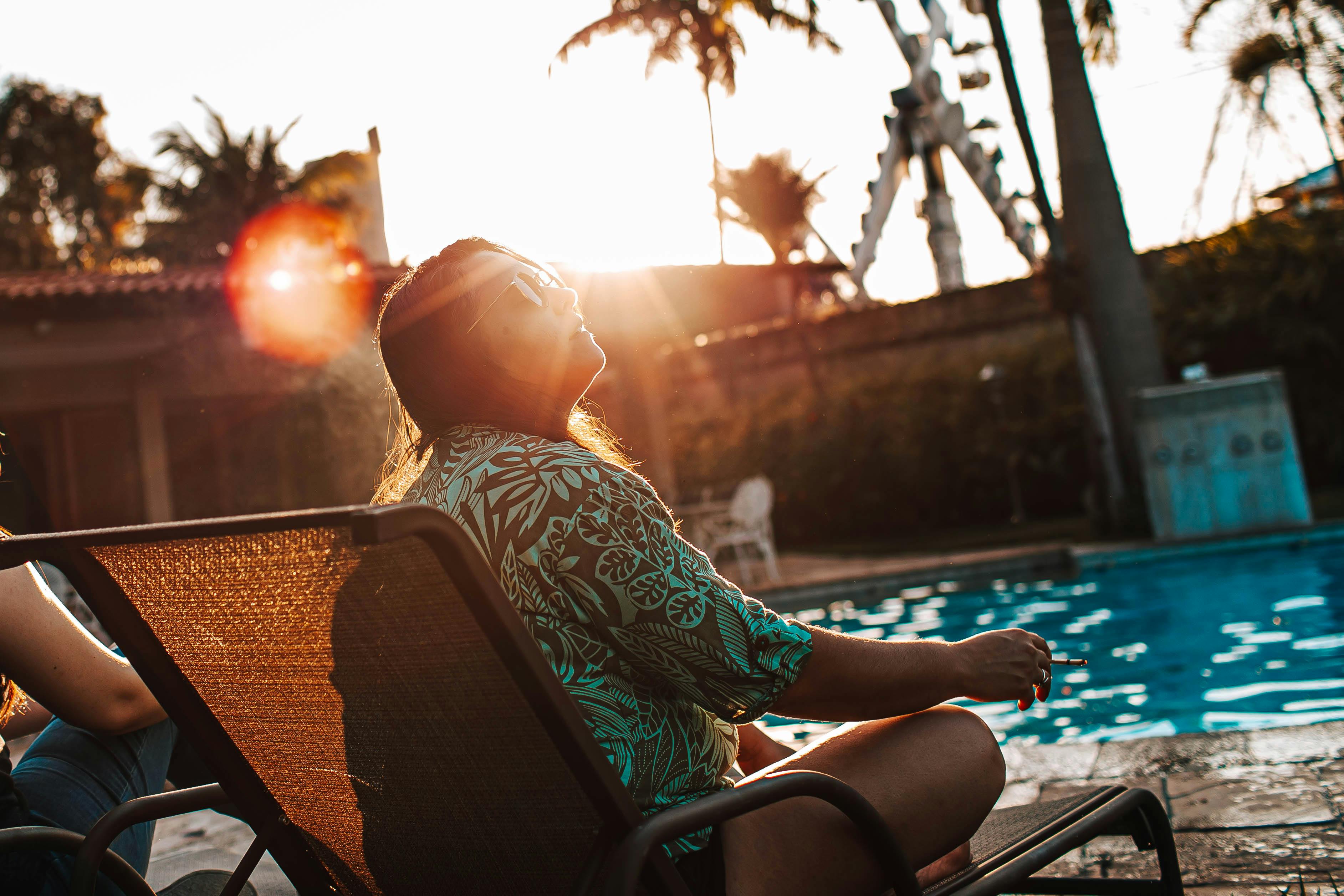 Woman Sitting on Pool Chair · Free Stock Photo