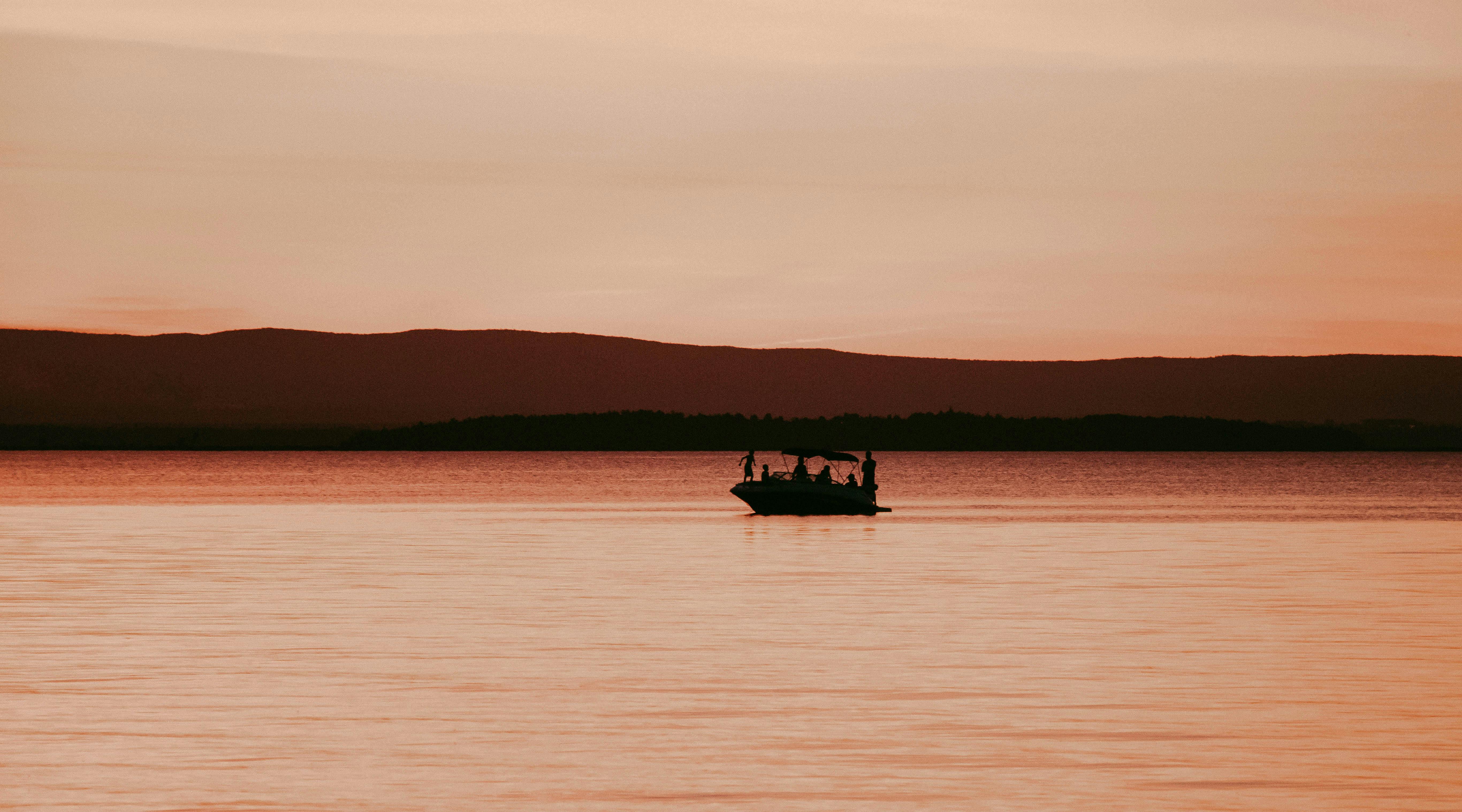People Riding on Boat During Sunset · Free Stock Photo