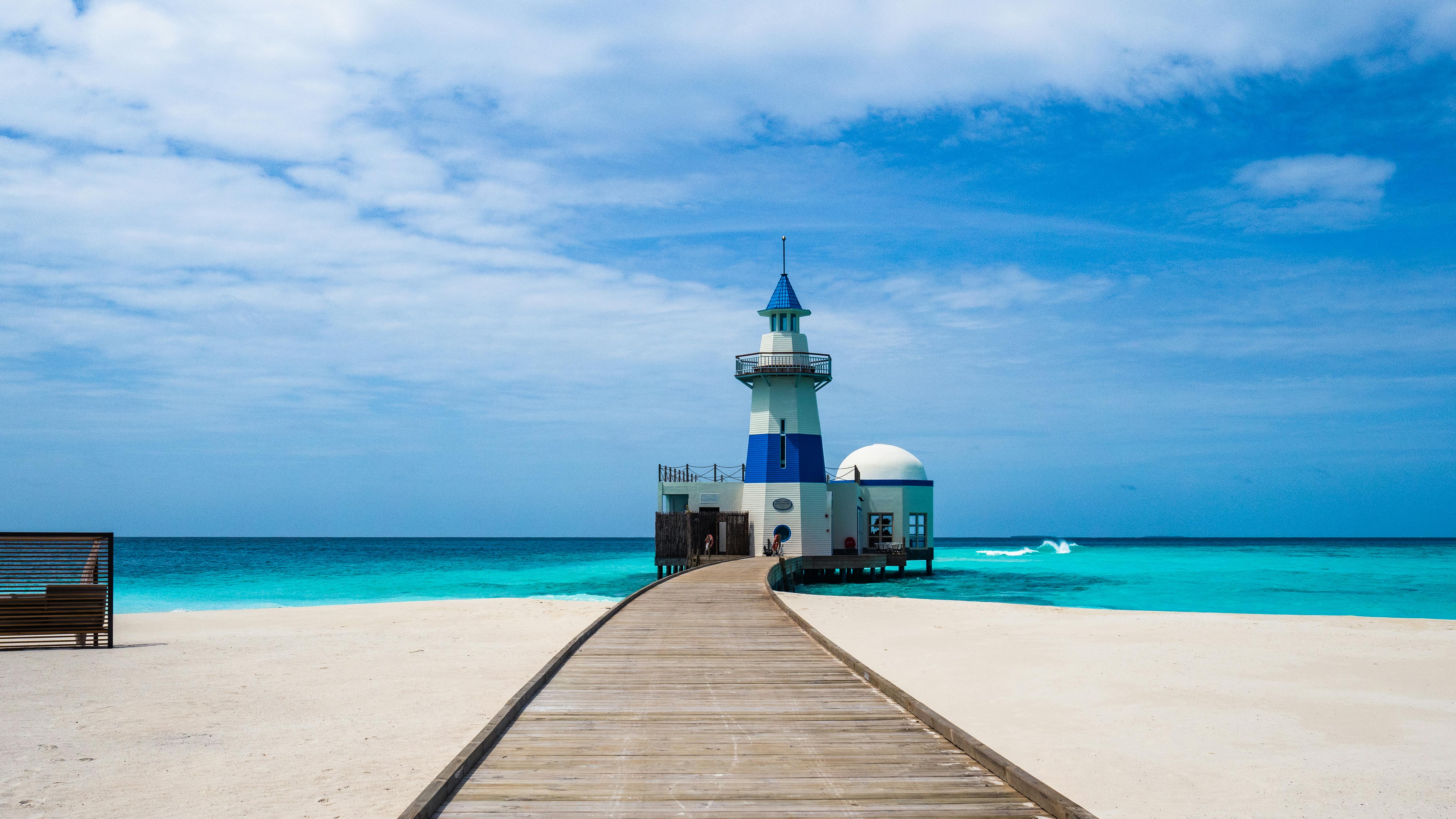 White And Blue Lighthouse Near Sea Under Blue Sky · Free Stock Photo