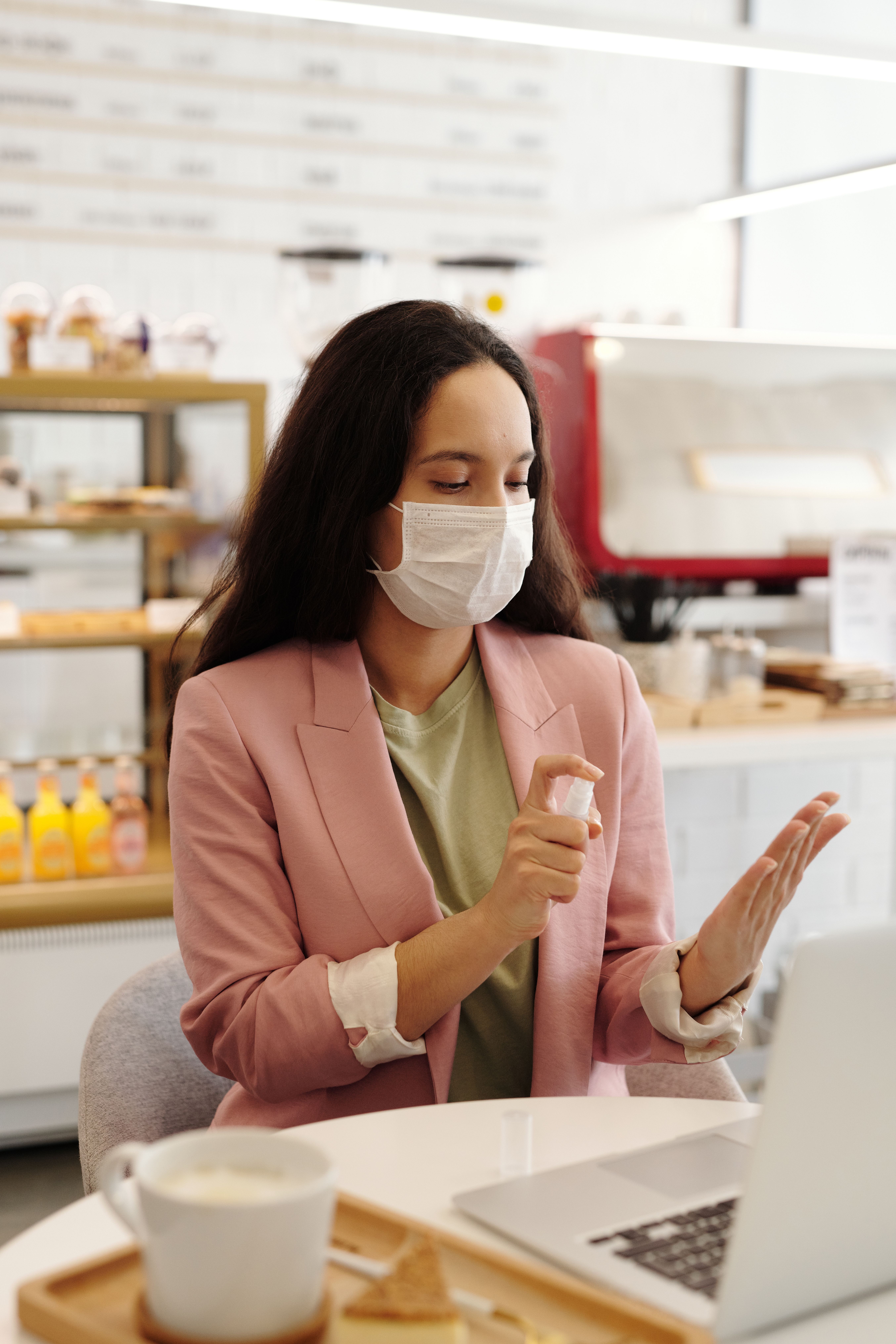 Woman Wearing Face Mask while Cleaning Her Hands with Sanitizer · Free ...