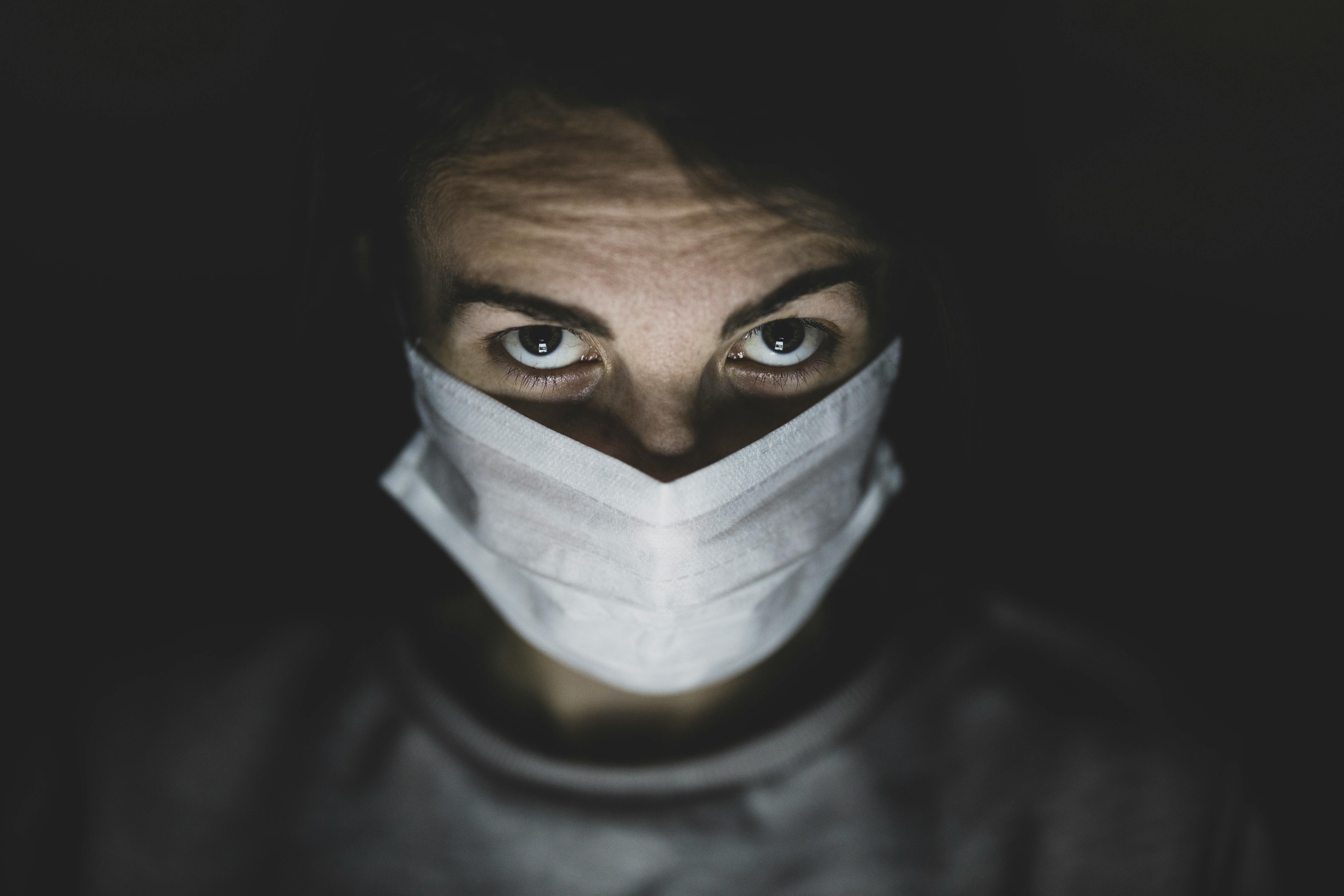 Man Wearing Face Mask In A Dark Room · Free Stock Photo