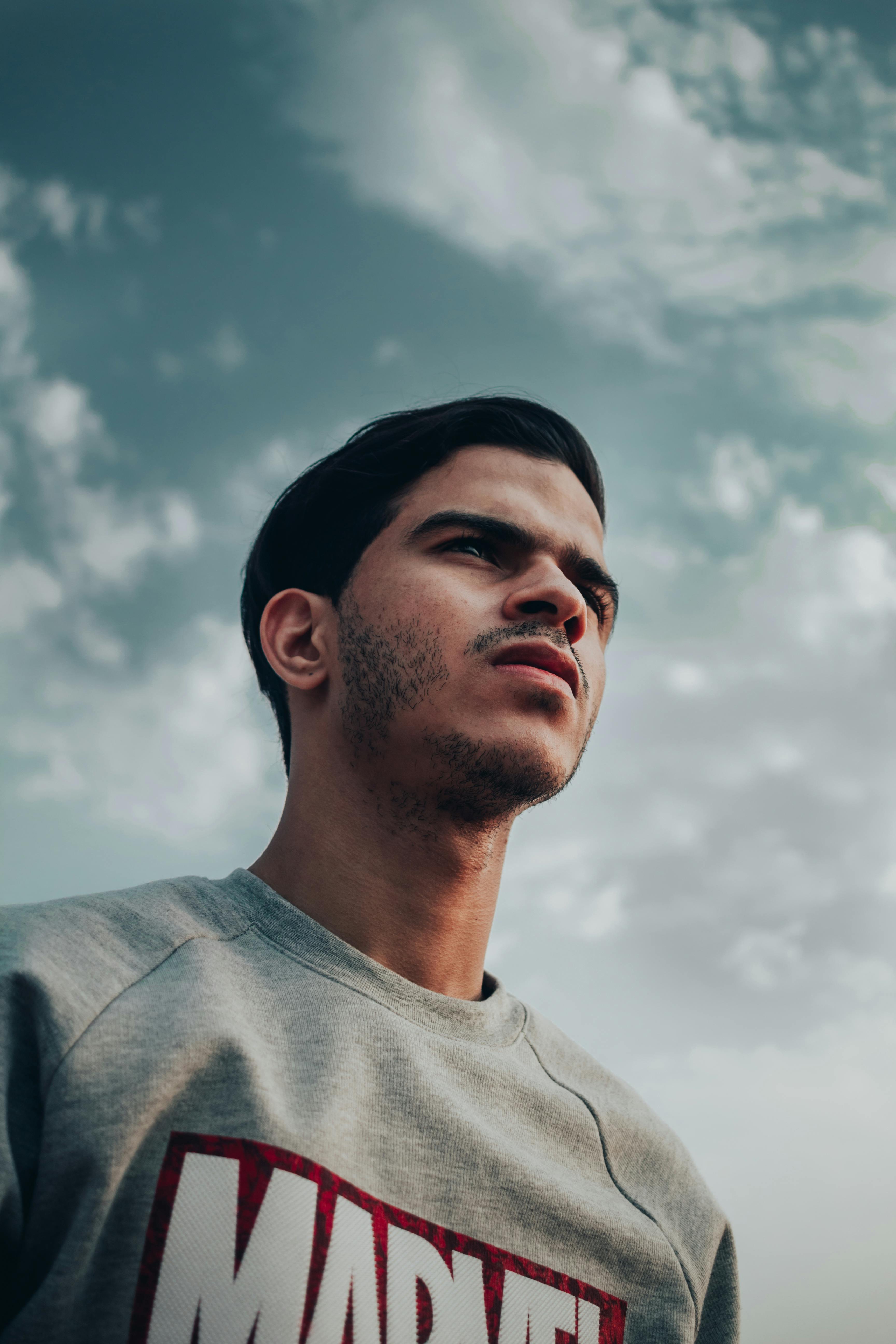 Low Angle Photography of Man Drinking Gray Labeled Can · Free Stock Photo