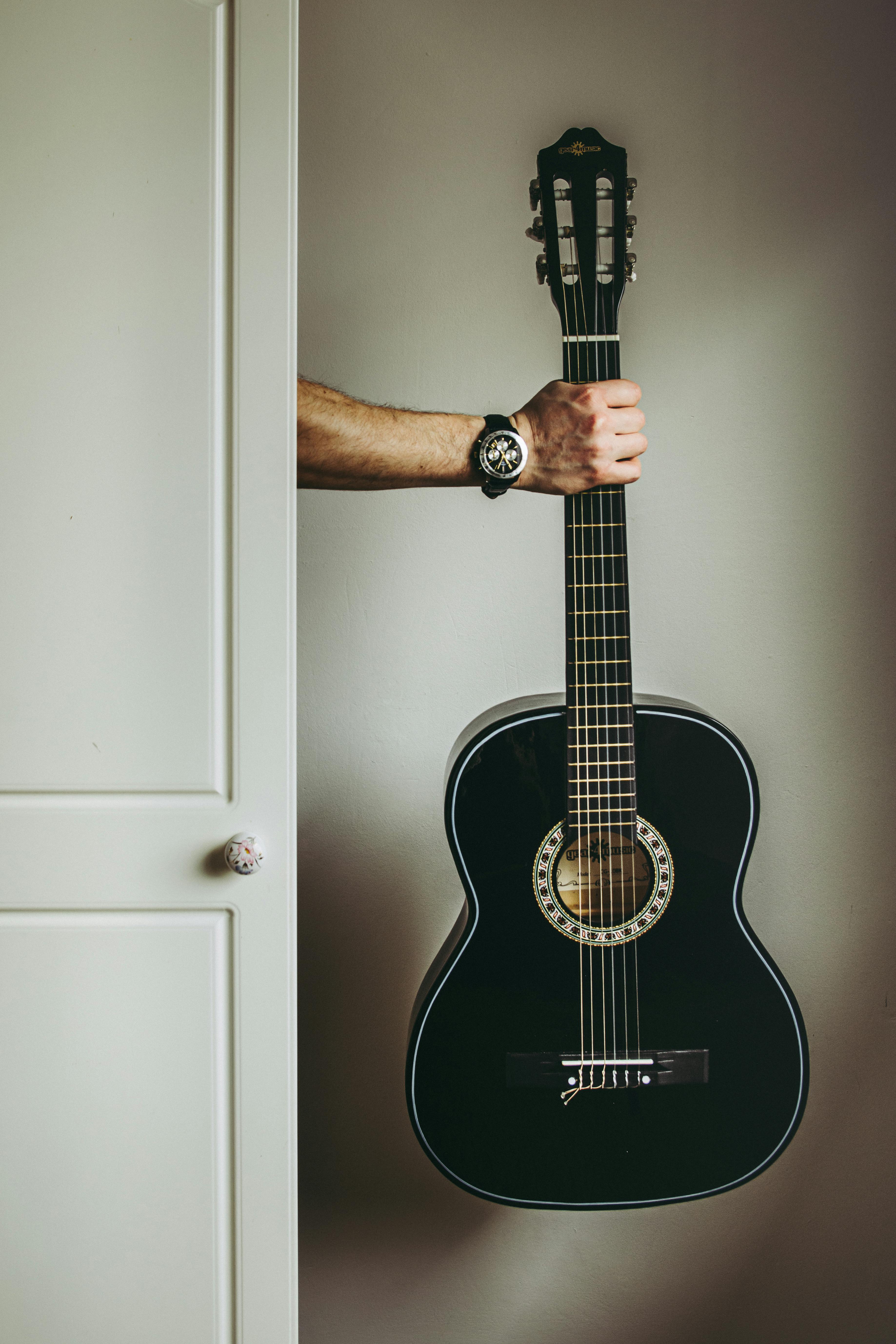 Person Holding Black Acoustic Guitar · Free Stock Photo