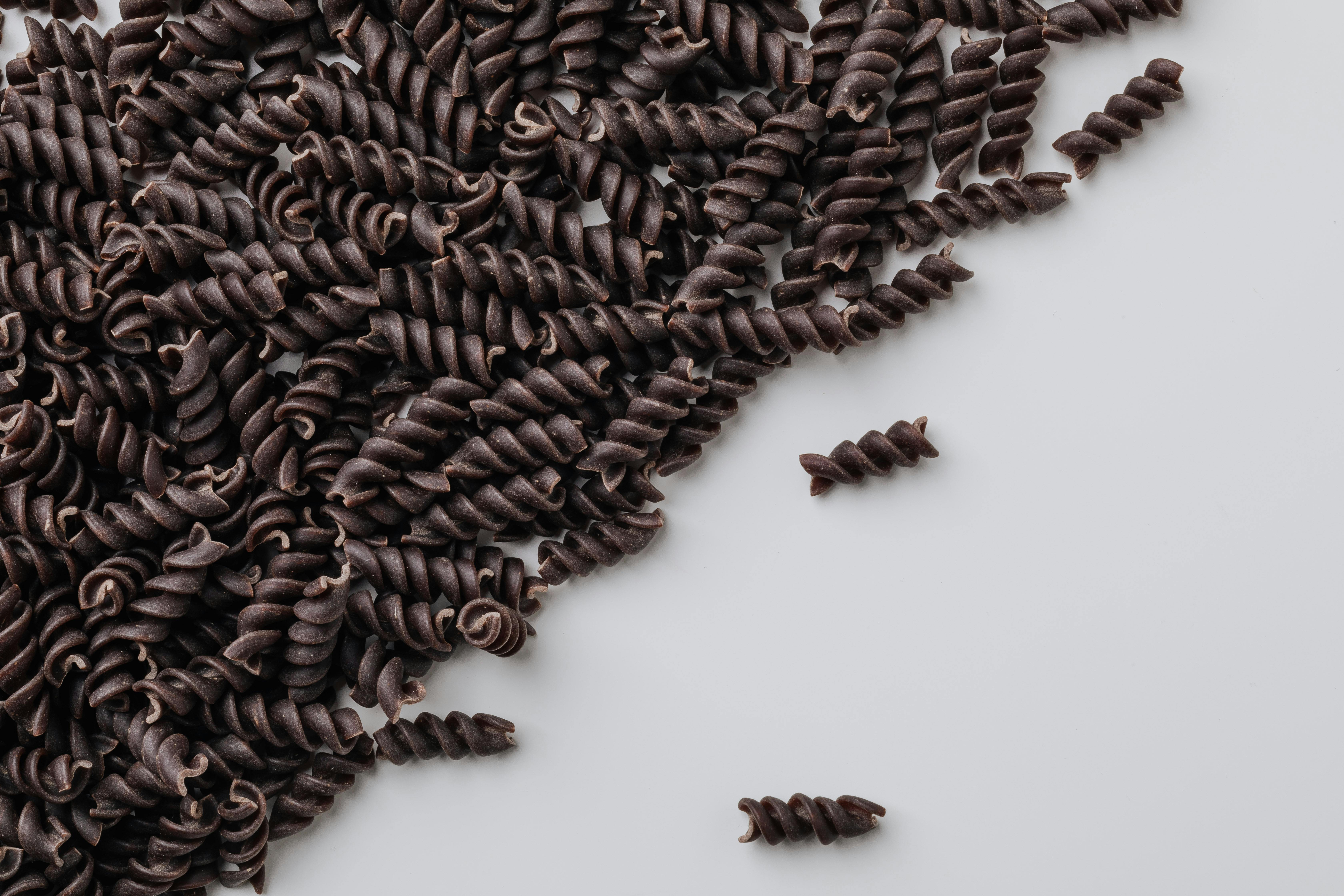 Close-Up Photo Of Black Fusilli · Free Stock Photo