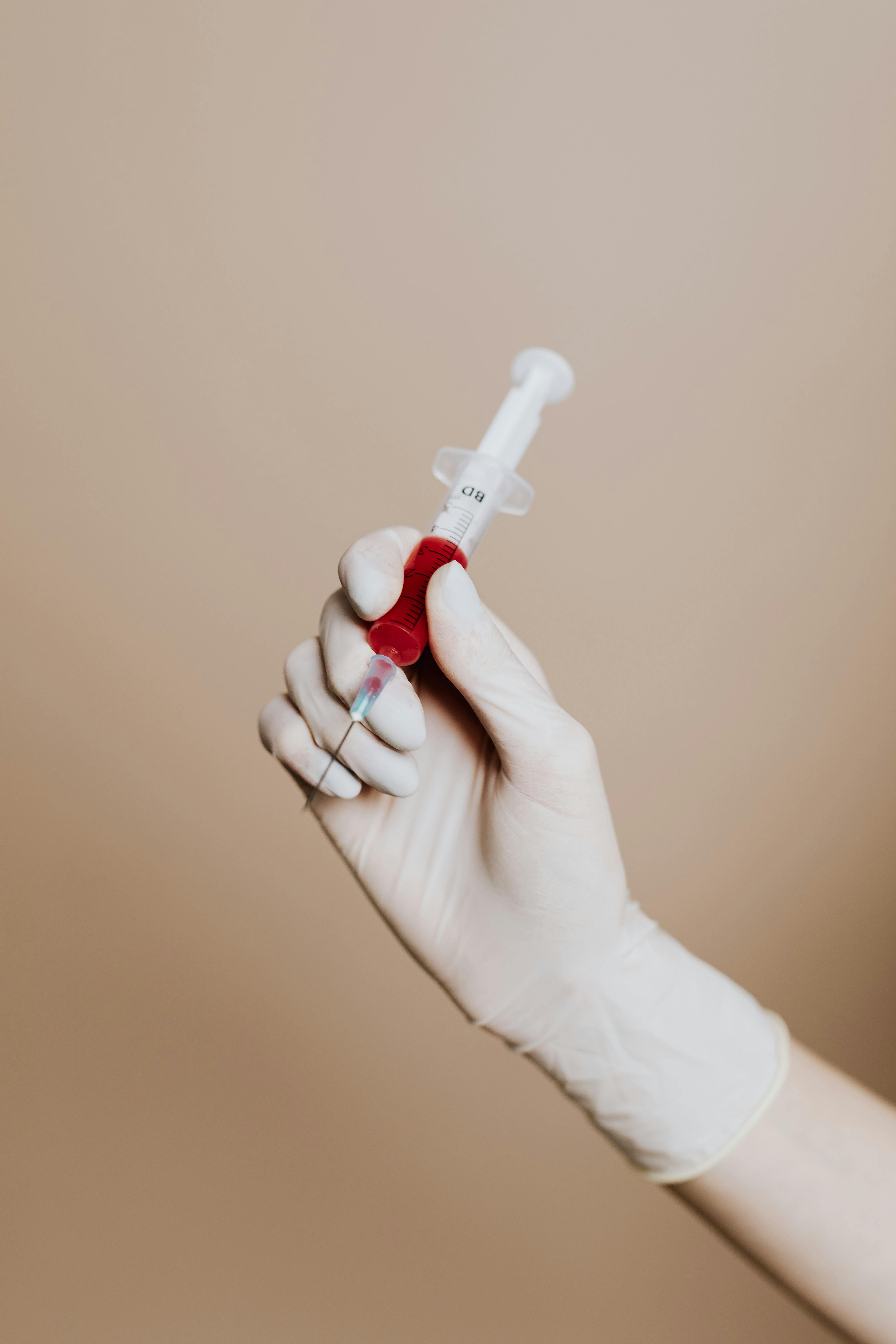 Photo Of Person Holding Syringe · Free Stock Photo