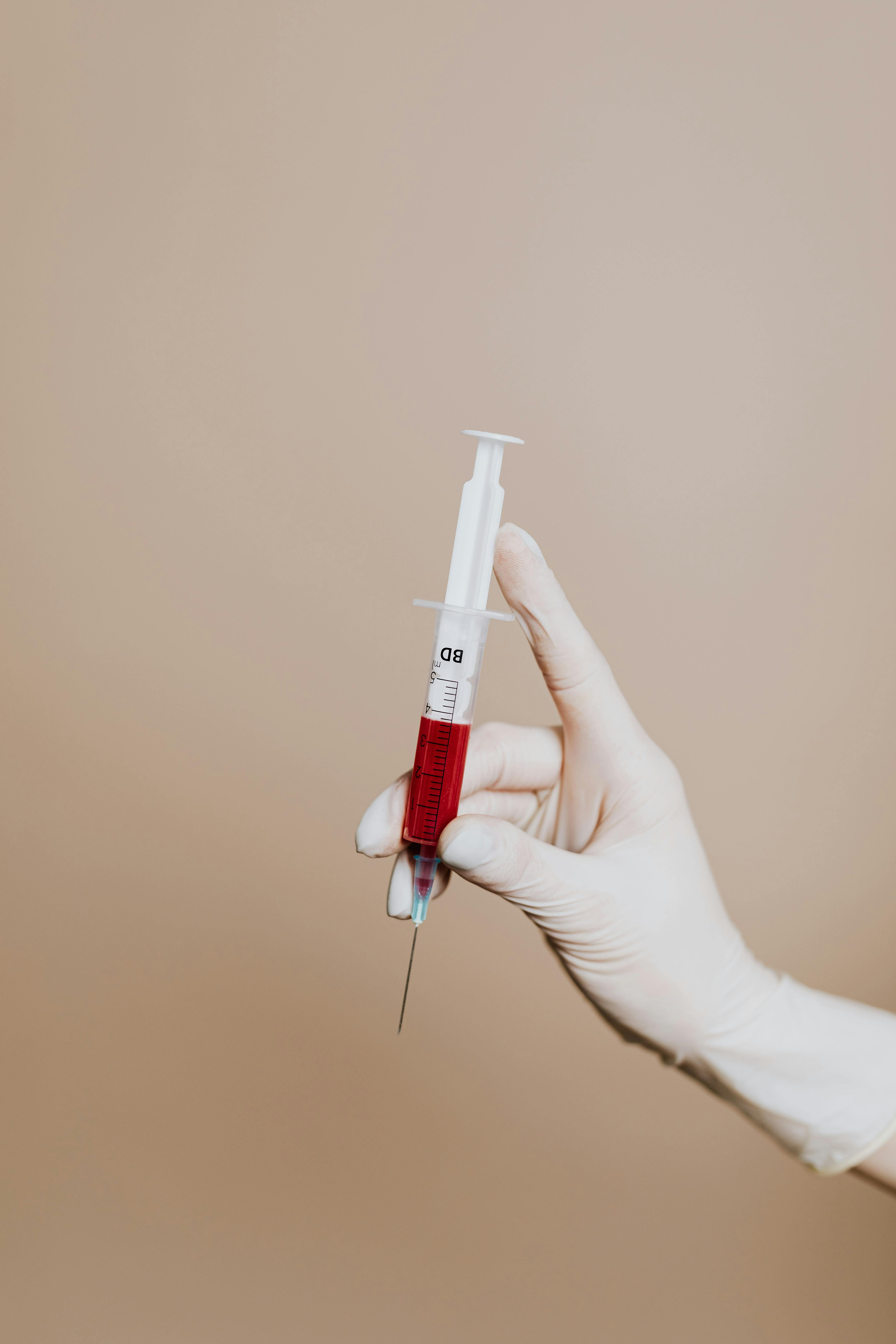 Photo Of Person Holding Syringe · Free Stock Photo