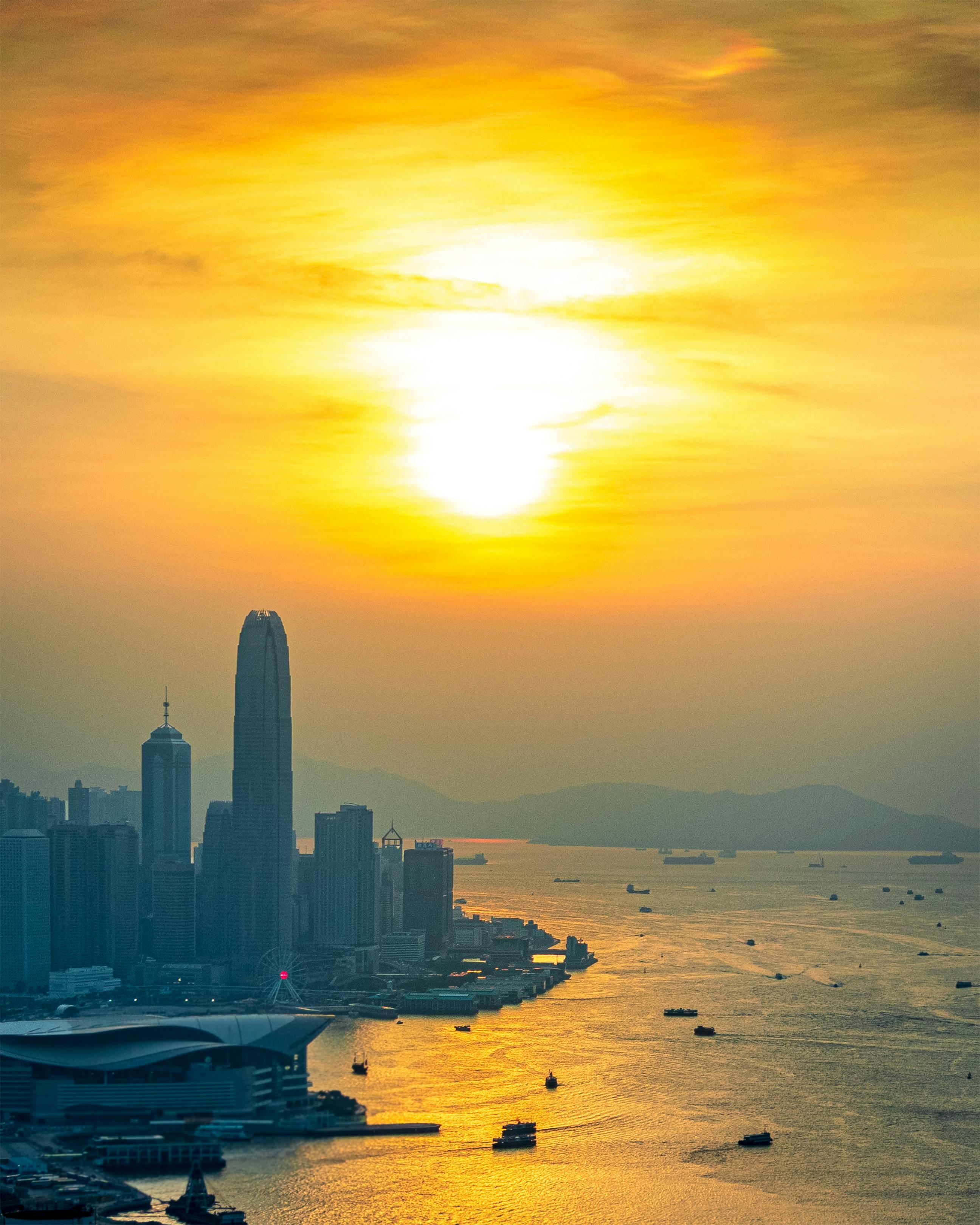 Buildings Beside the Ocean during Sunset · Free Stock Photo