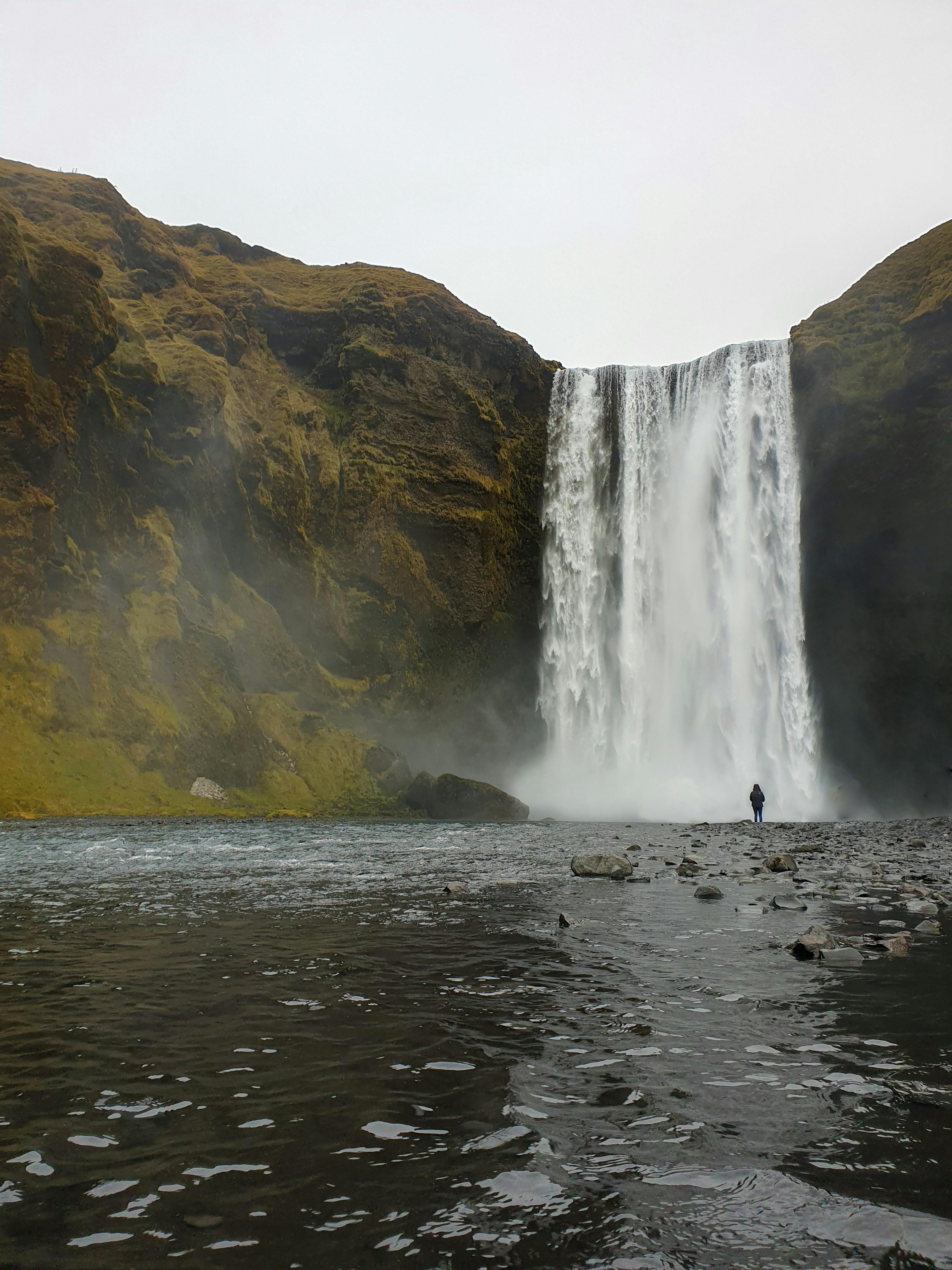 Person Standing Near the Waterfalls · Free Stock Photo