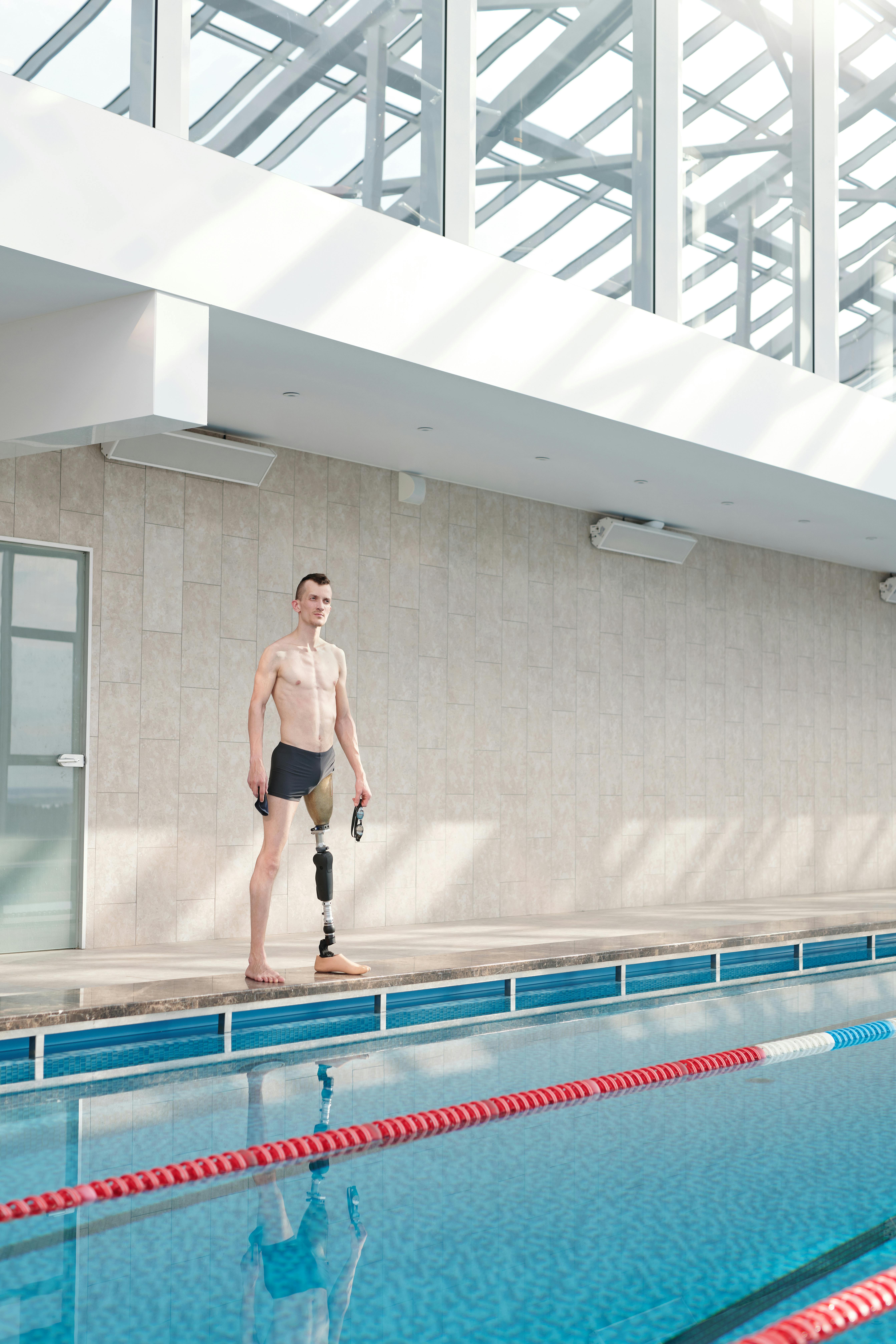 Man Sitting Beside Pool · Free Stock Photo